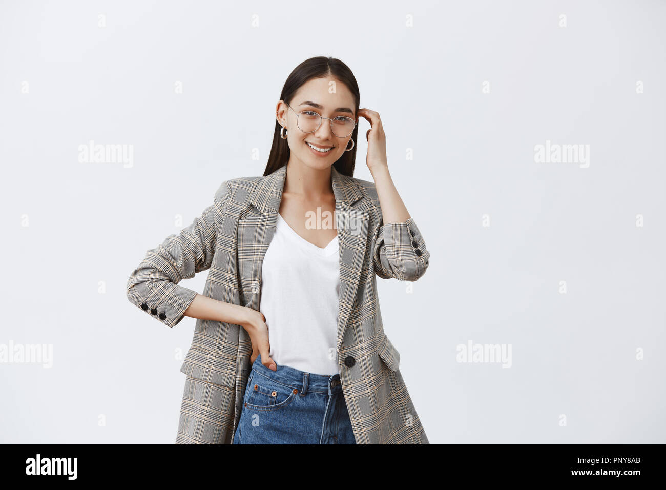 Horizontal shot of feminine fashionable cute woman in glasses and ...