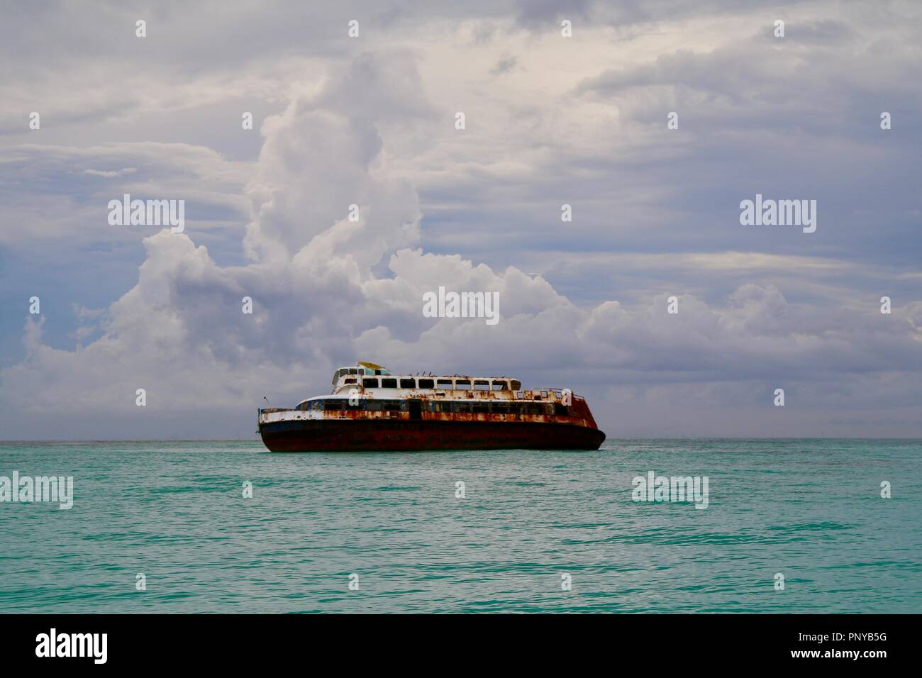 Ship wrecked during a hurricane in the Caribbean with a storm building ...