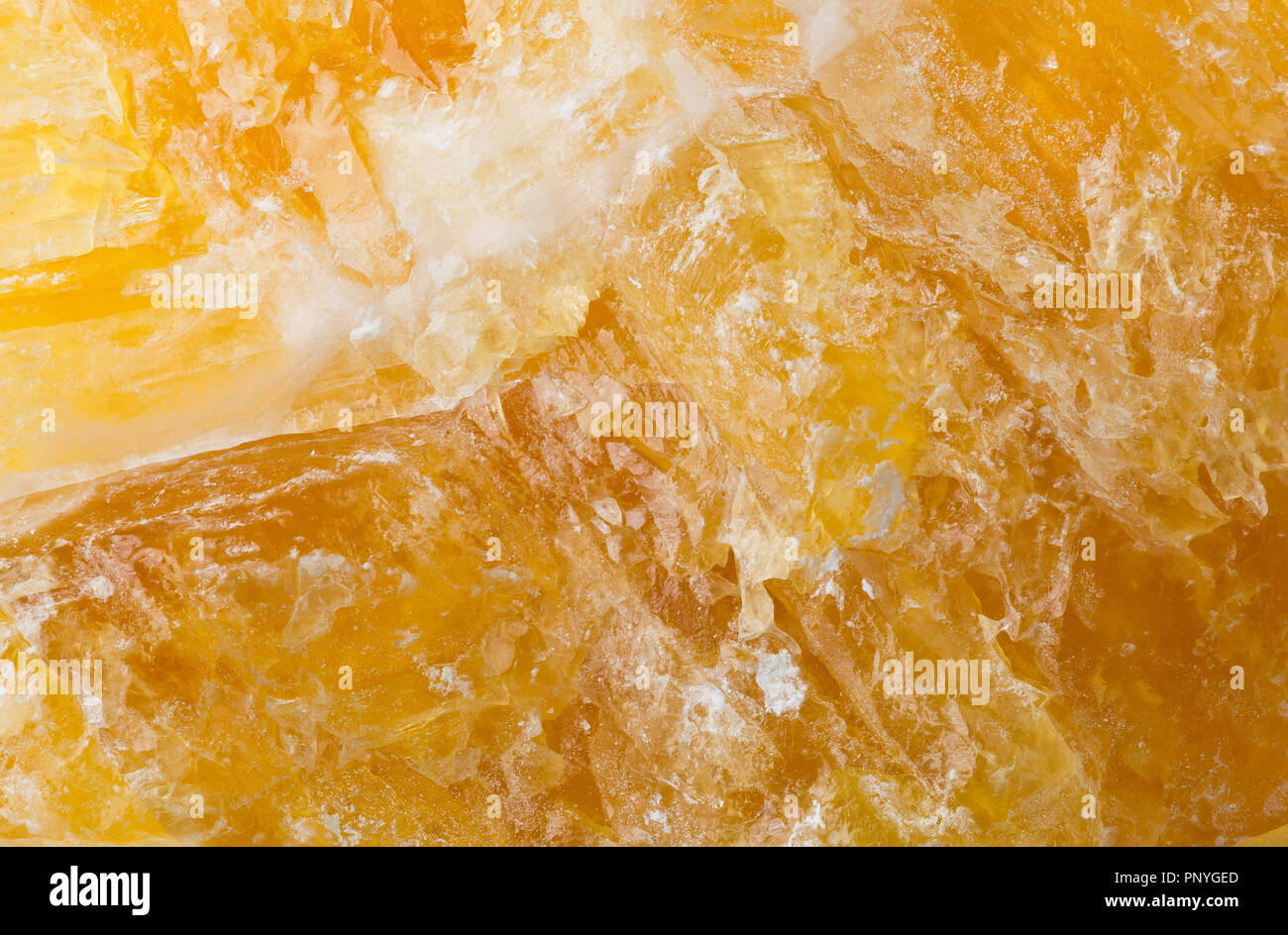 Raw, uncut yellow calcite (CaCO3) from Mexico close up frame filling ...