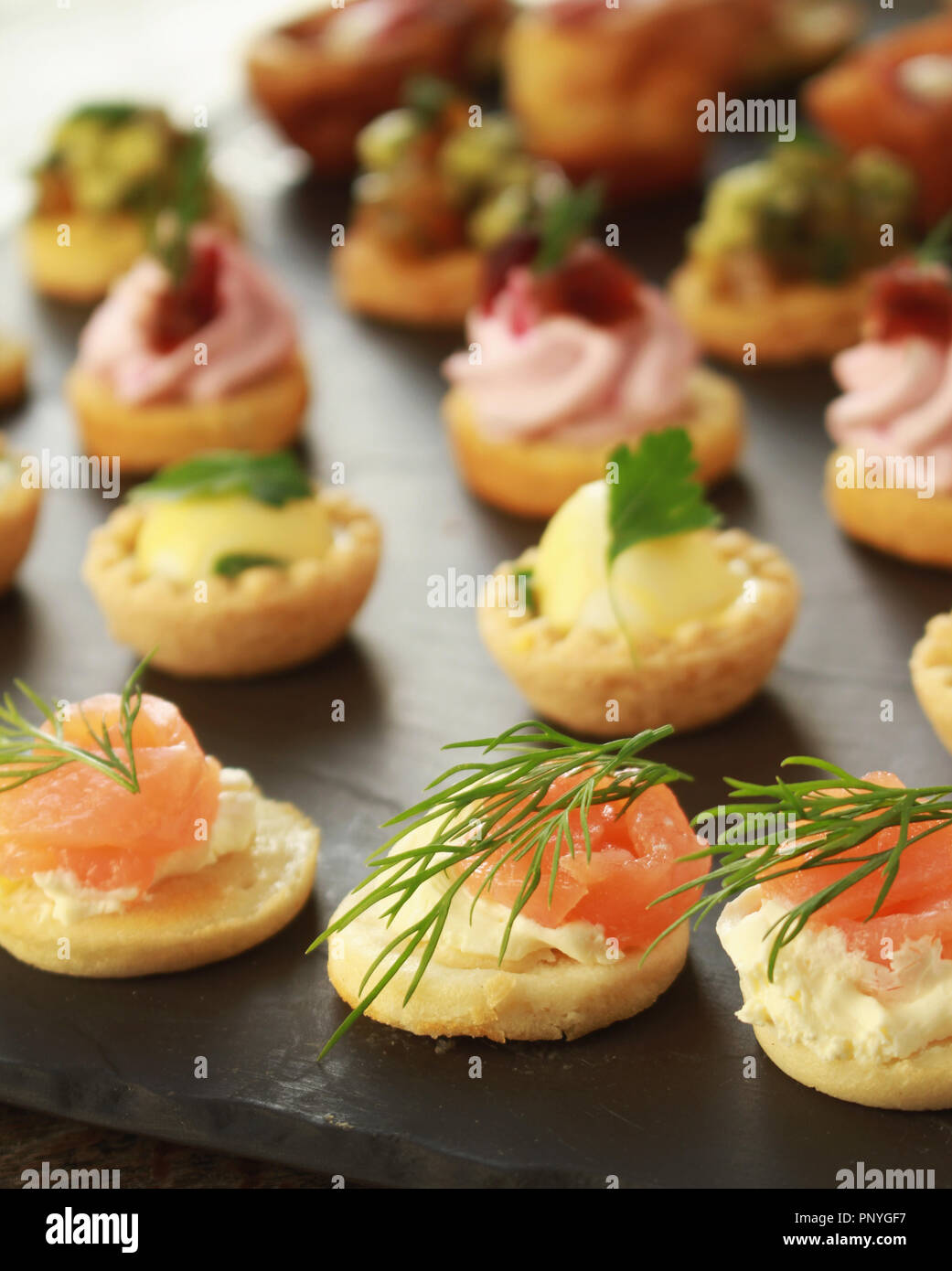 mixed canape selection onslate platter Stock Photo - Alamy