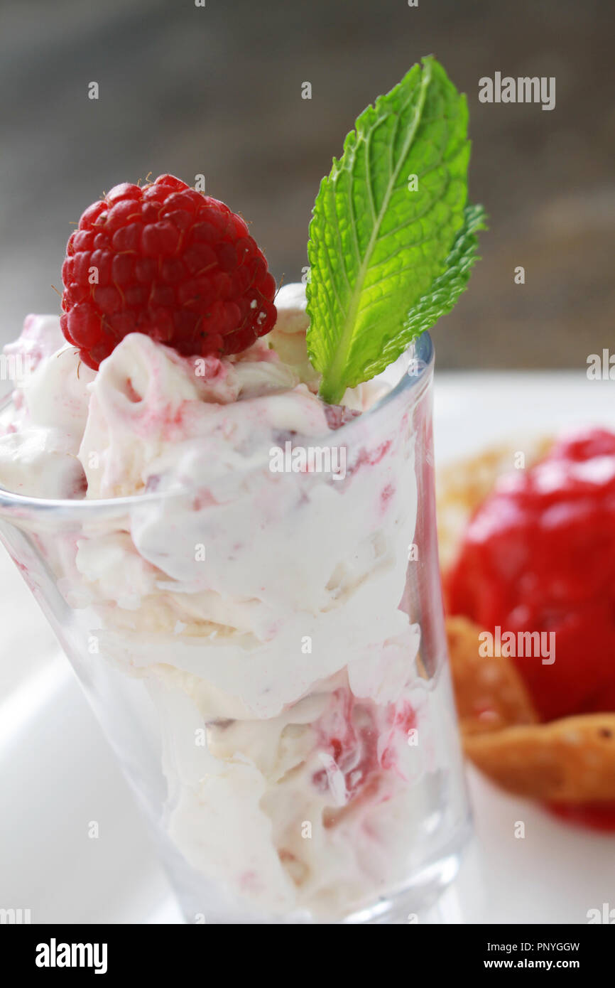 plated eaton mess dessert with raspberries Stock Photo - Alamy