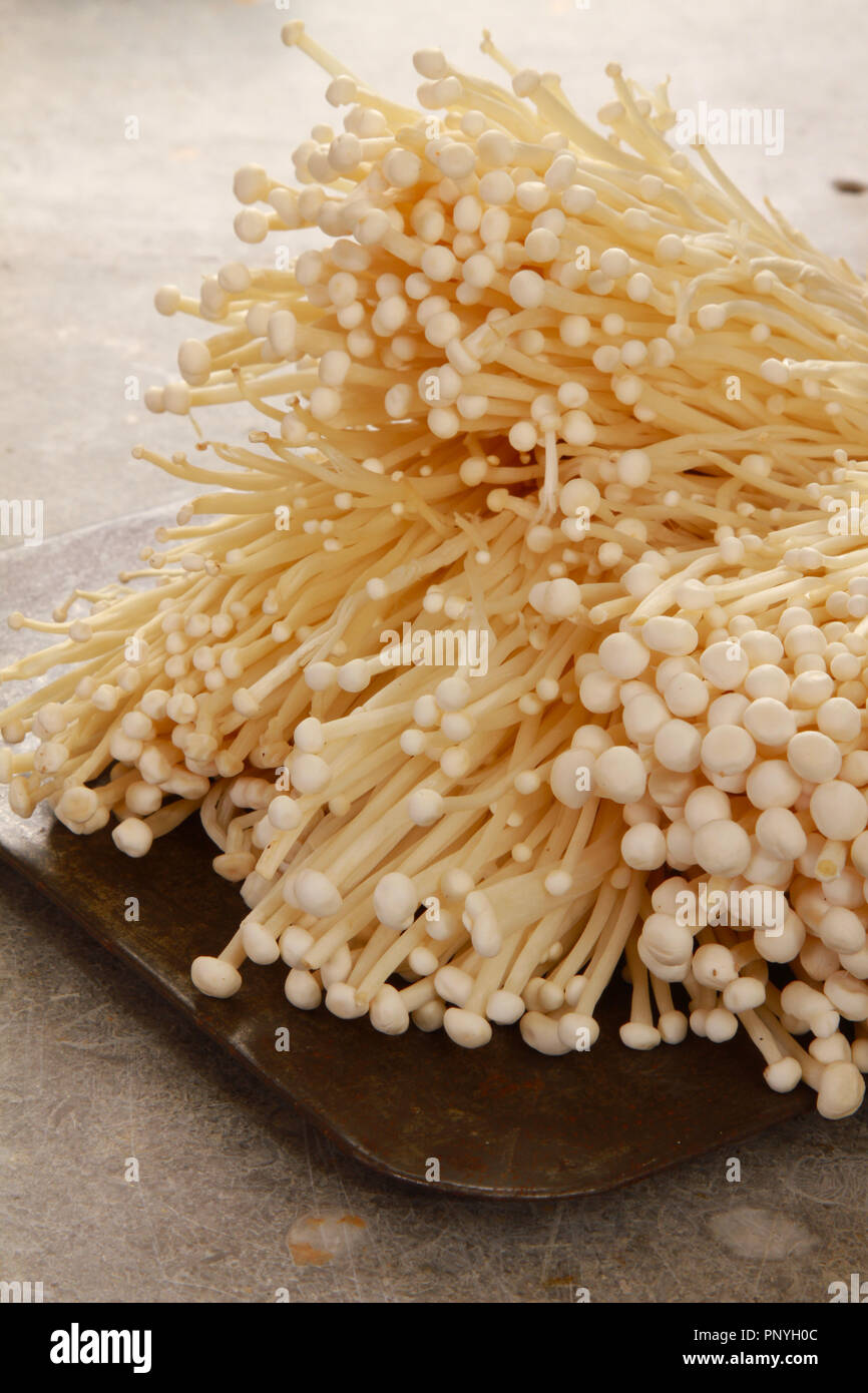 preparing fresh east asian white enoki mushrooms Stock Photo - Alamy