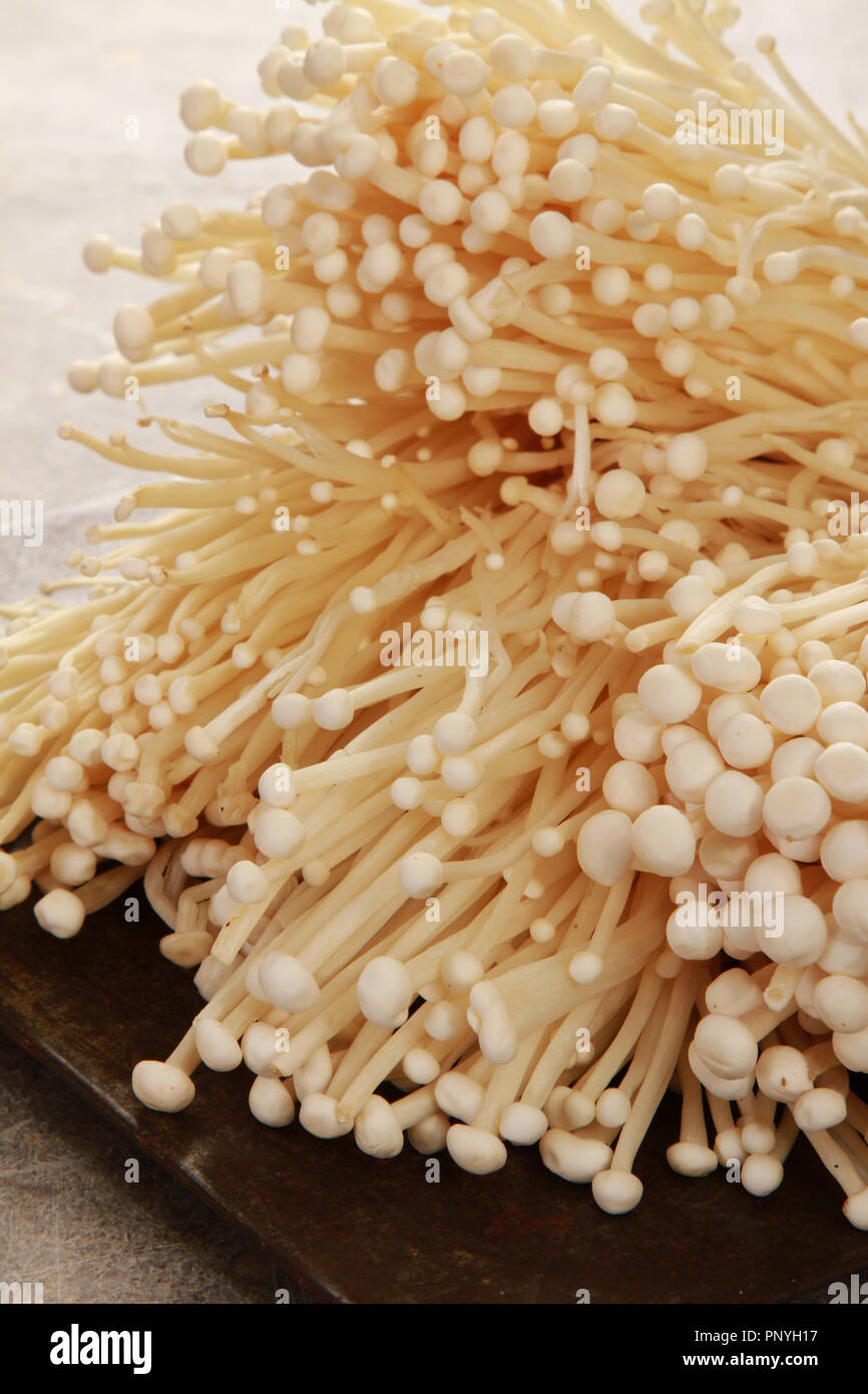 preparing fresh east asian white enoki mushrooms Stock Photo - Alamy
