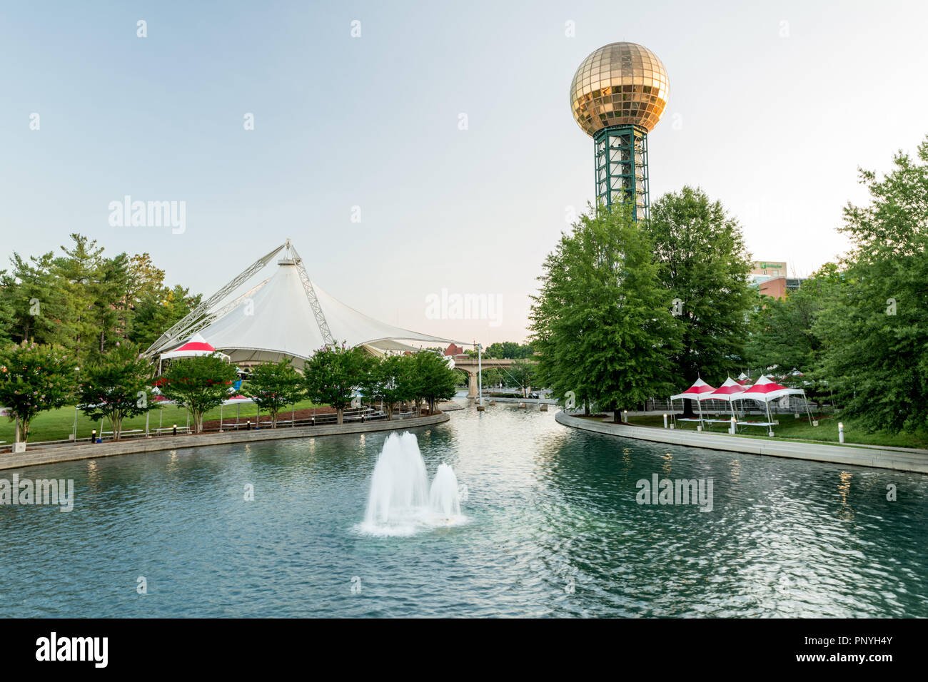 Fountain in a pond before a gold colored sphere Stock Photo - Alamy