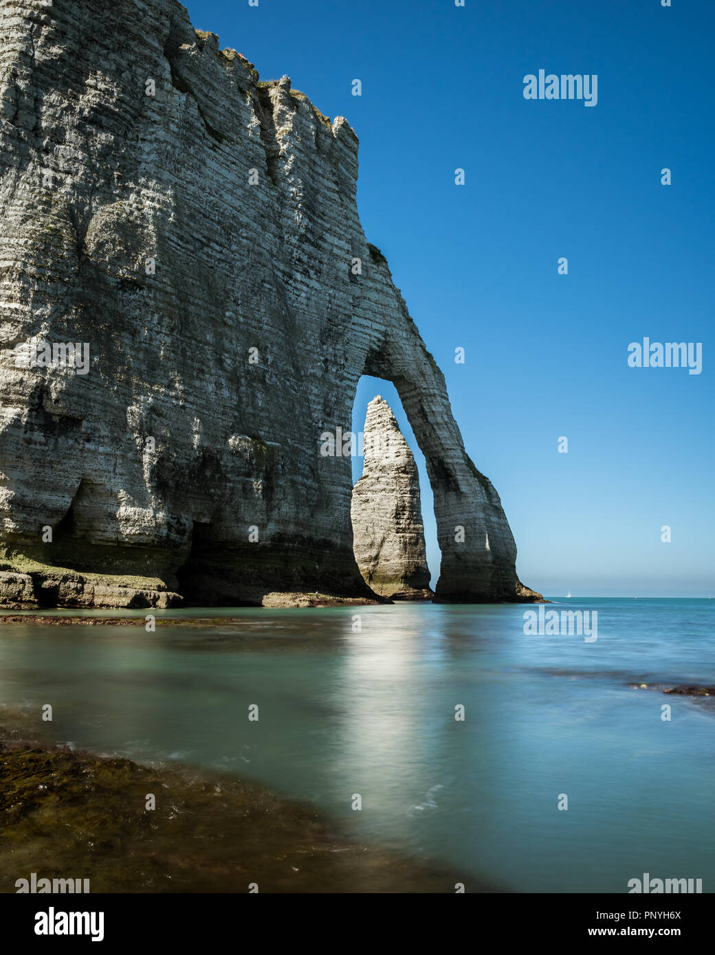 Chalk cliffs of Etretat (Normandy France) with the natural arch Porte d ...