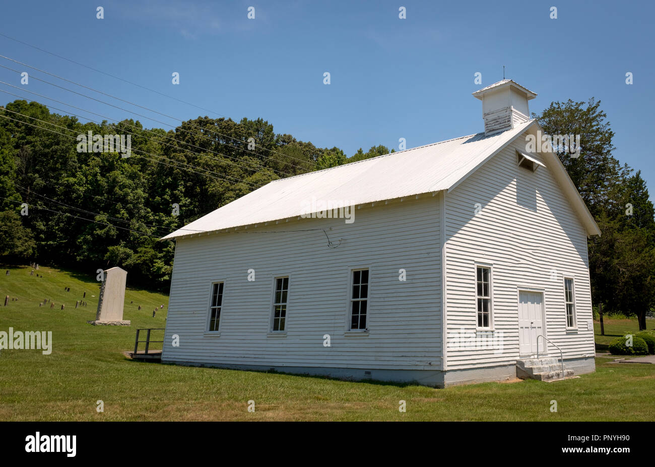 White classic church with cemetery in the back Stock Photo - Alamy