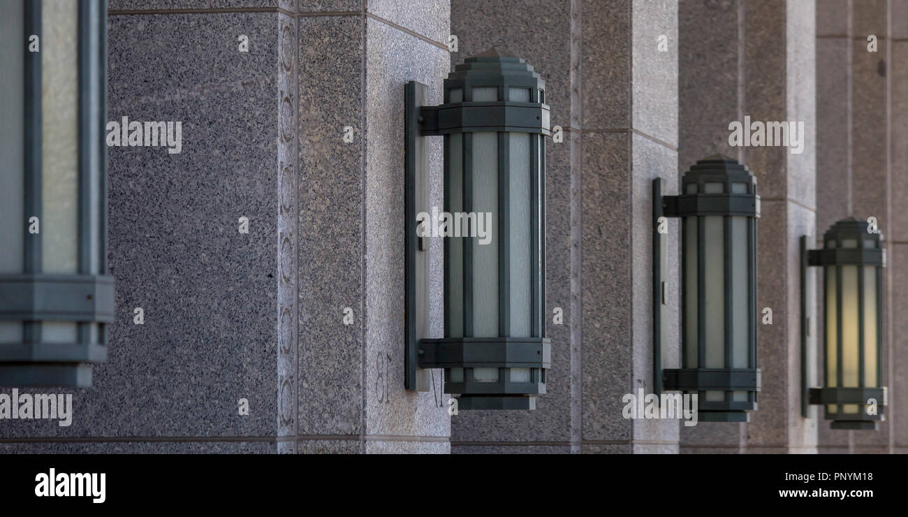 Columns with decorative wall lamps in a row Stock Photo - Alamy