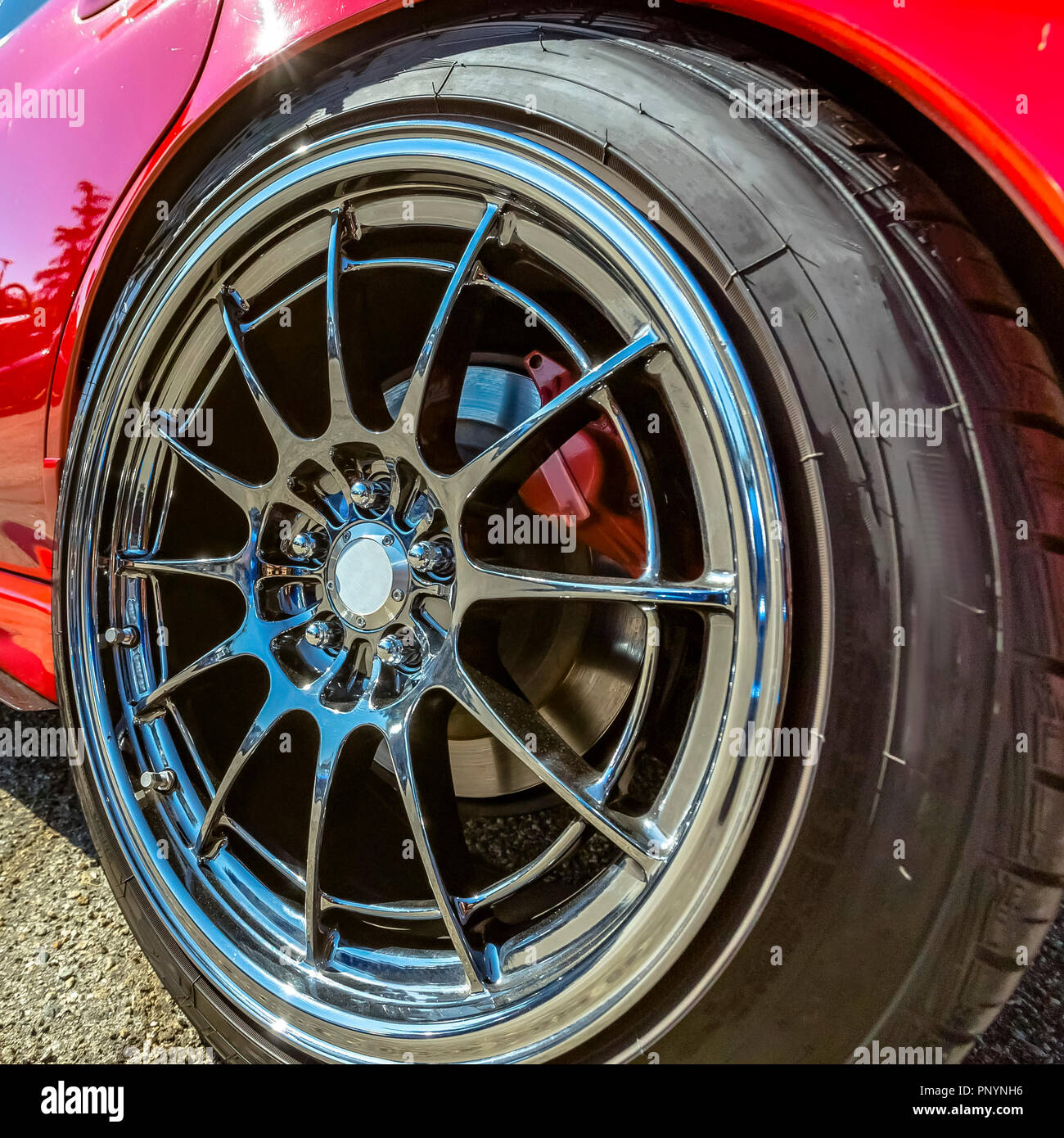 Red car with silver rim on its wheels Stock Photo - Alamy