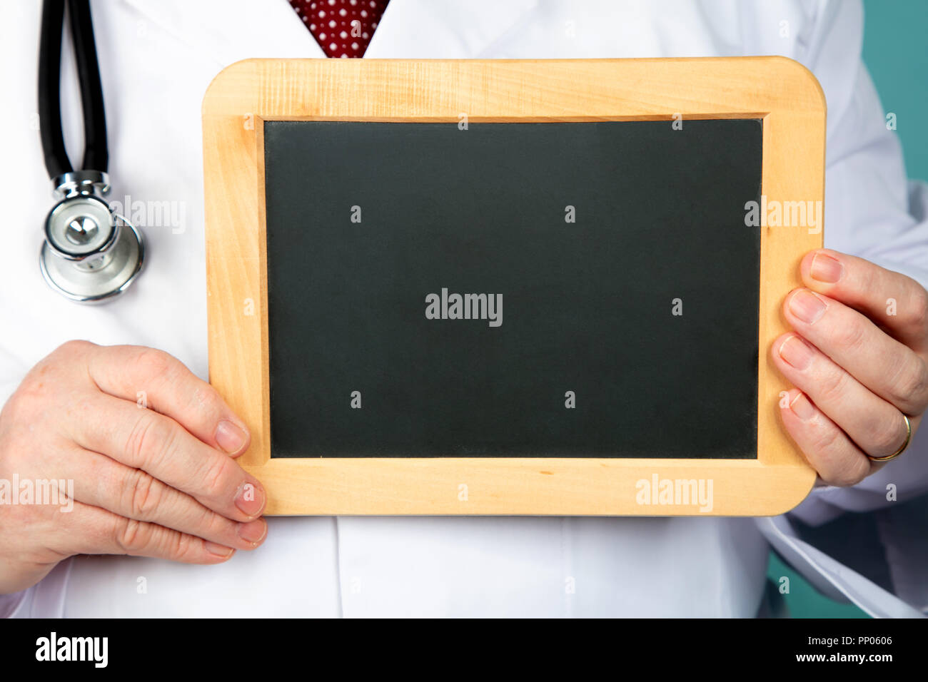 Doctor holding blank chalkboard in Detail Stock Photo - Alamy