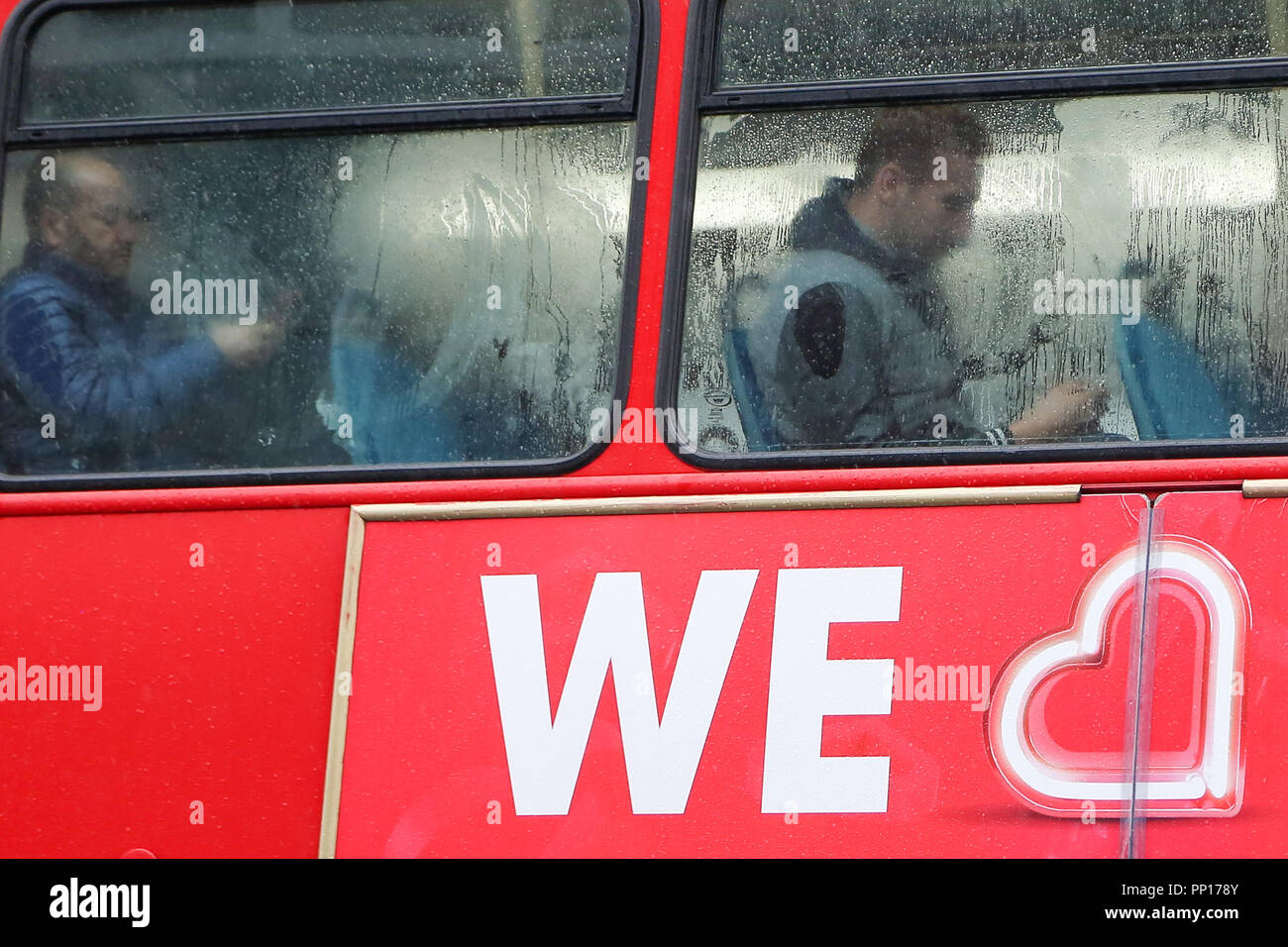 London. UK 23 Sept 2018 - Commuters seen through a steamed bus window ...