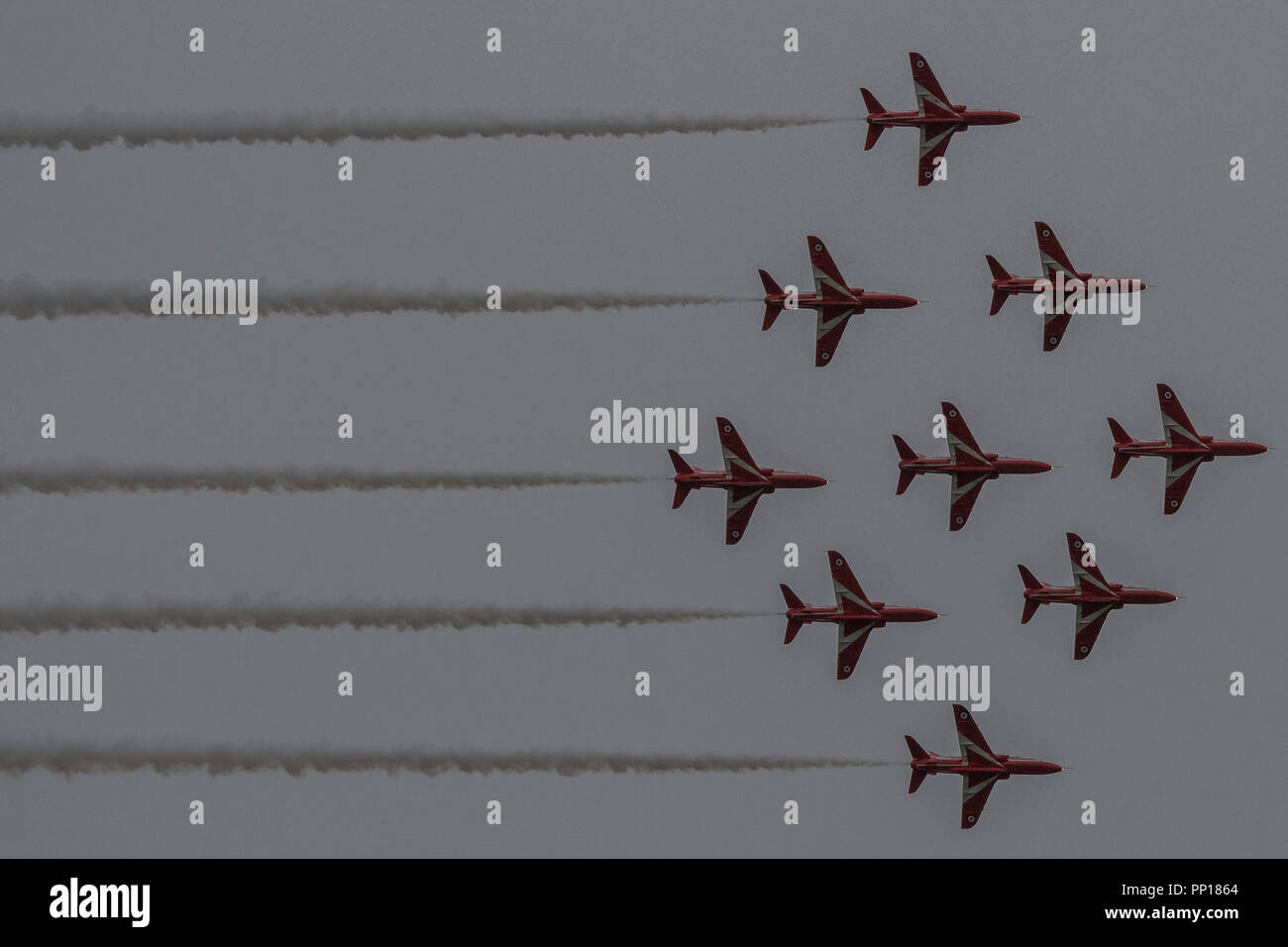 Duxford, UK. 22nd Sep, 2018. The Red Arrows display team in the rain ...