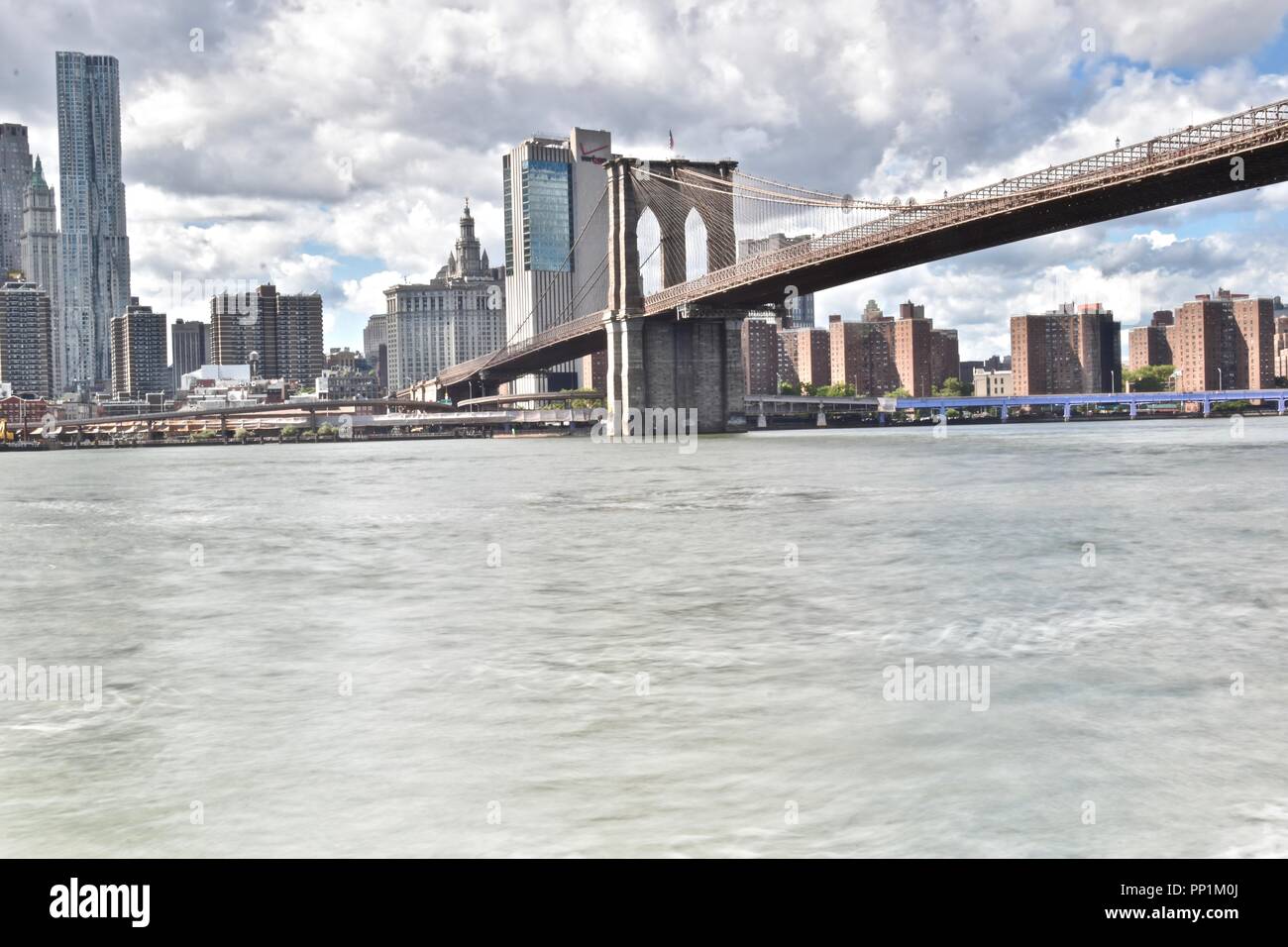 The iconic Brooklyn Bridge spanning the East River between Lower ... The iconic Brooklyn Bridge spanning the East River between Lower ...