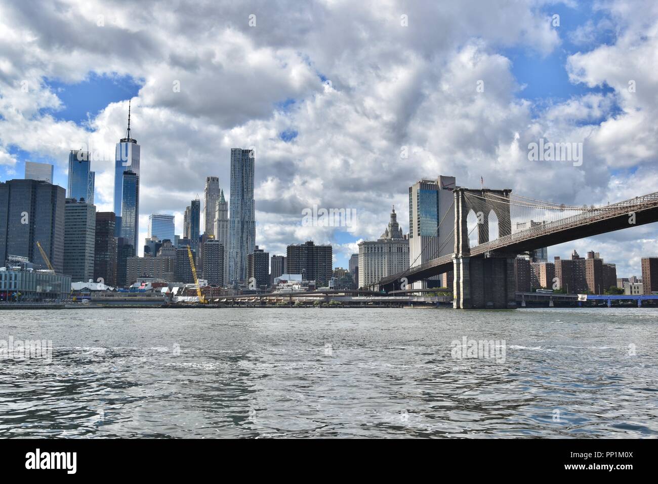 The iconic Brooklyn Bridge spanning the East River between Lower ... The iconic Brooklyn Bridge spanning the East River between Lower ...