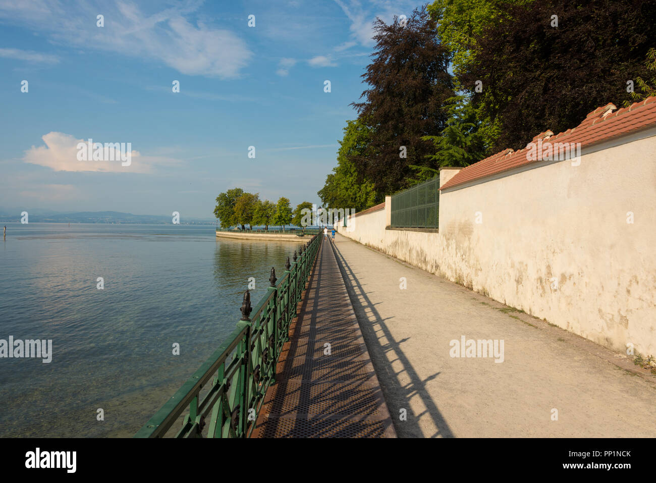 Footpath with old iron railing along the castle wall in the park at ...