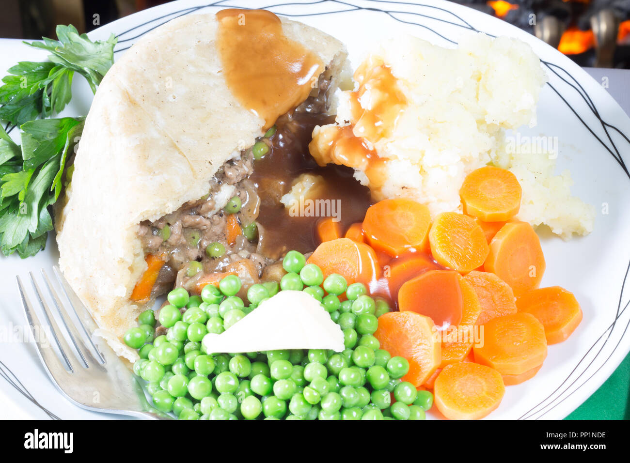 English pub/restaurant dish of steamed beef pudding served with garden ...