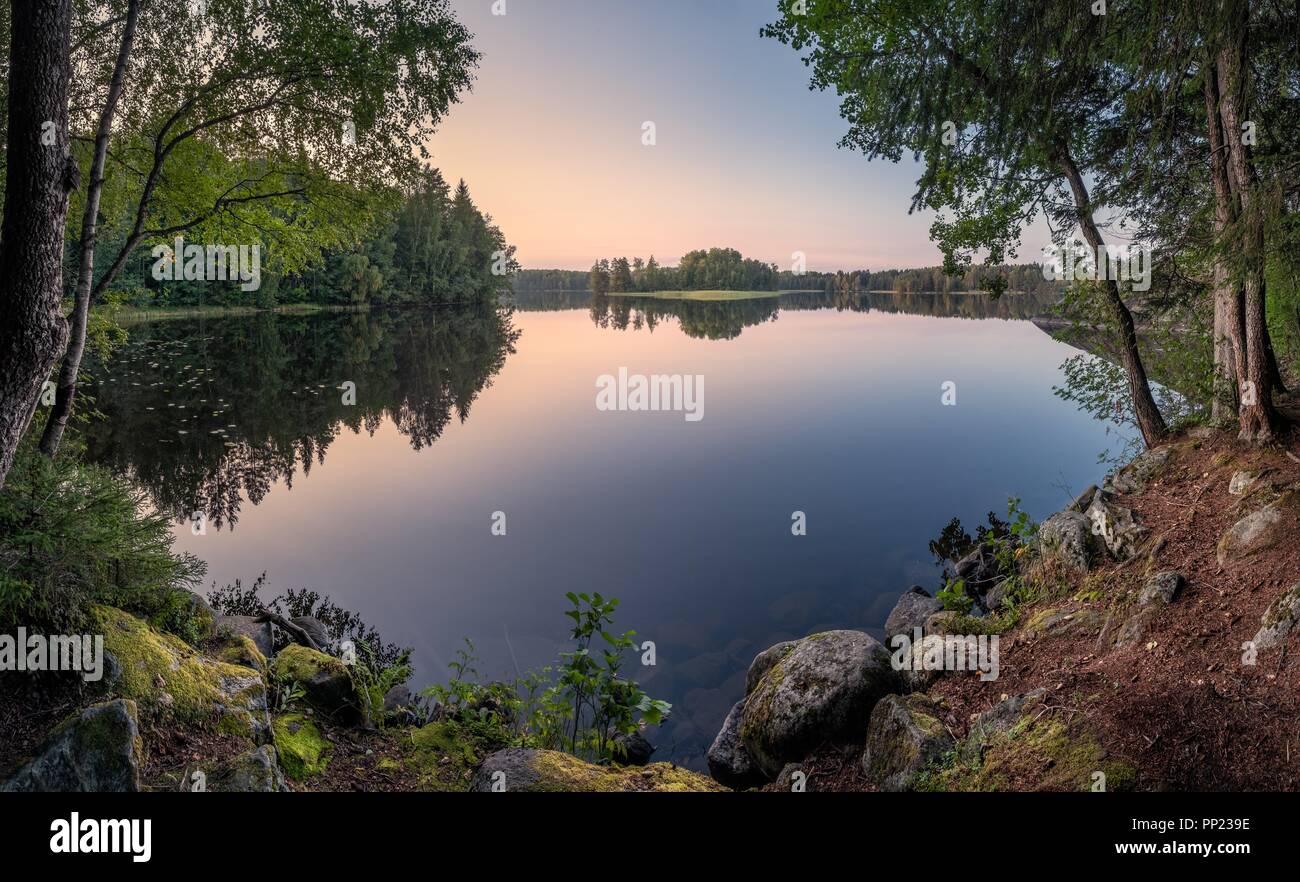 Scenic calm landscape with lake and sunset at autumn evening on Finland ...