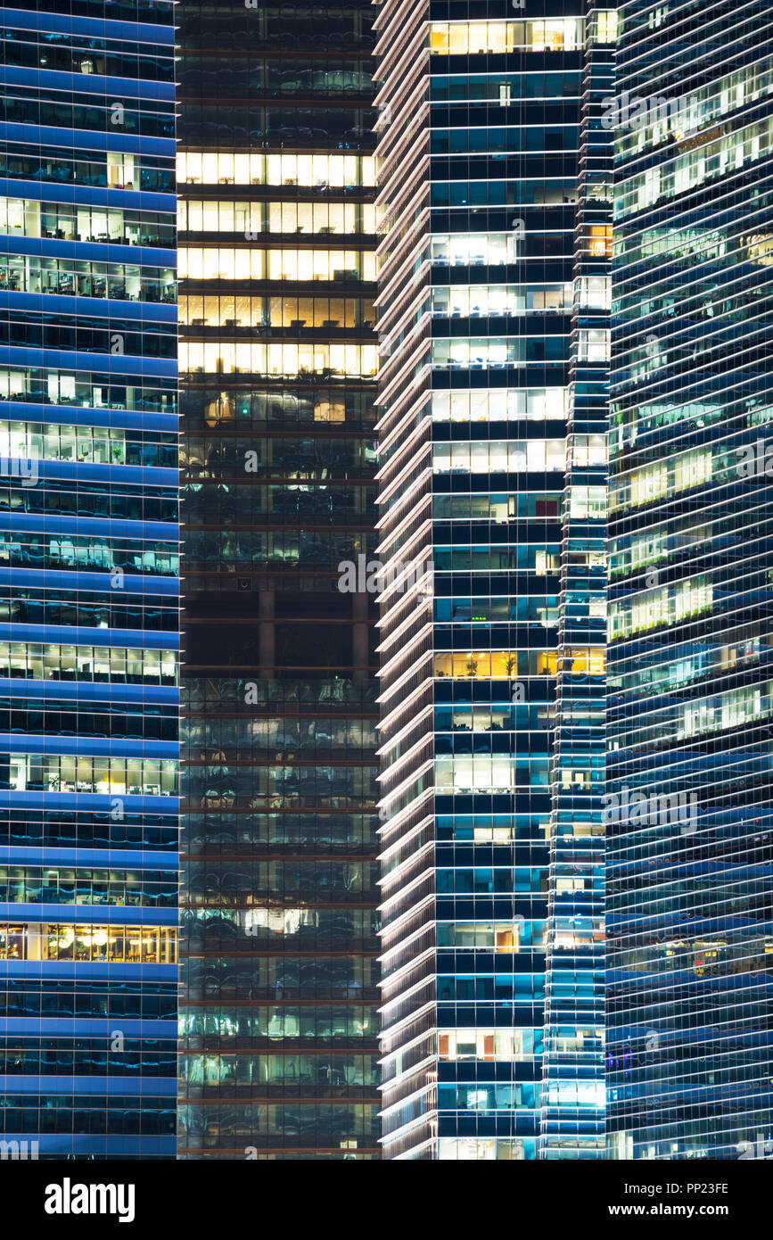 Glass facade of modern city high rise, buildings show lighting using by ...