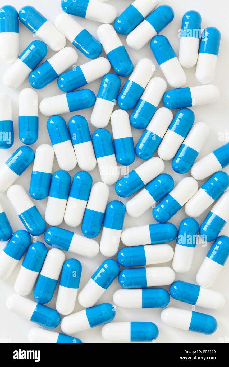 Close up picture of many capsules on white background Stock Photo - Alamy