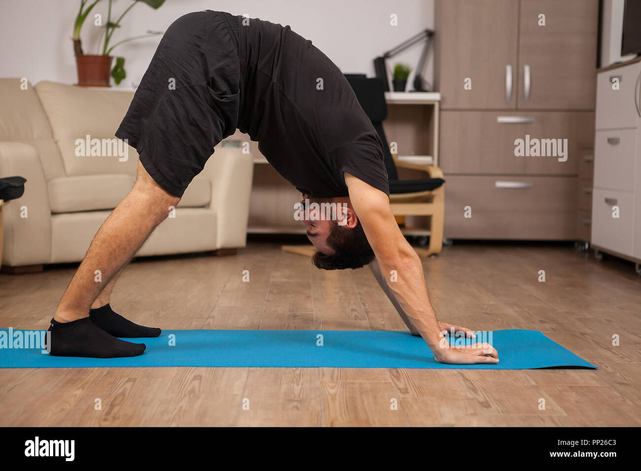 Adult man doing Dolphin yoga pose in his workout routine. Healthy ...