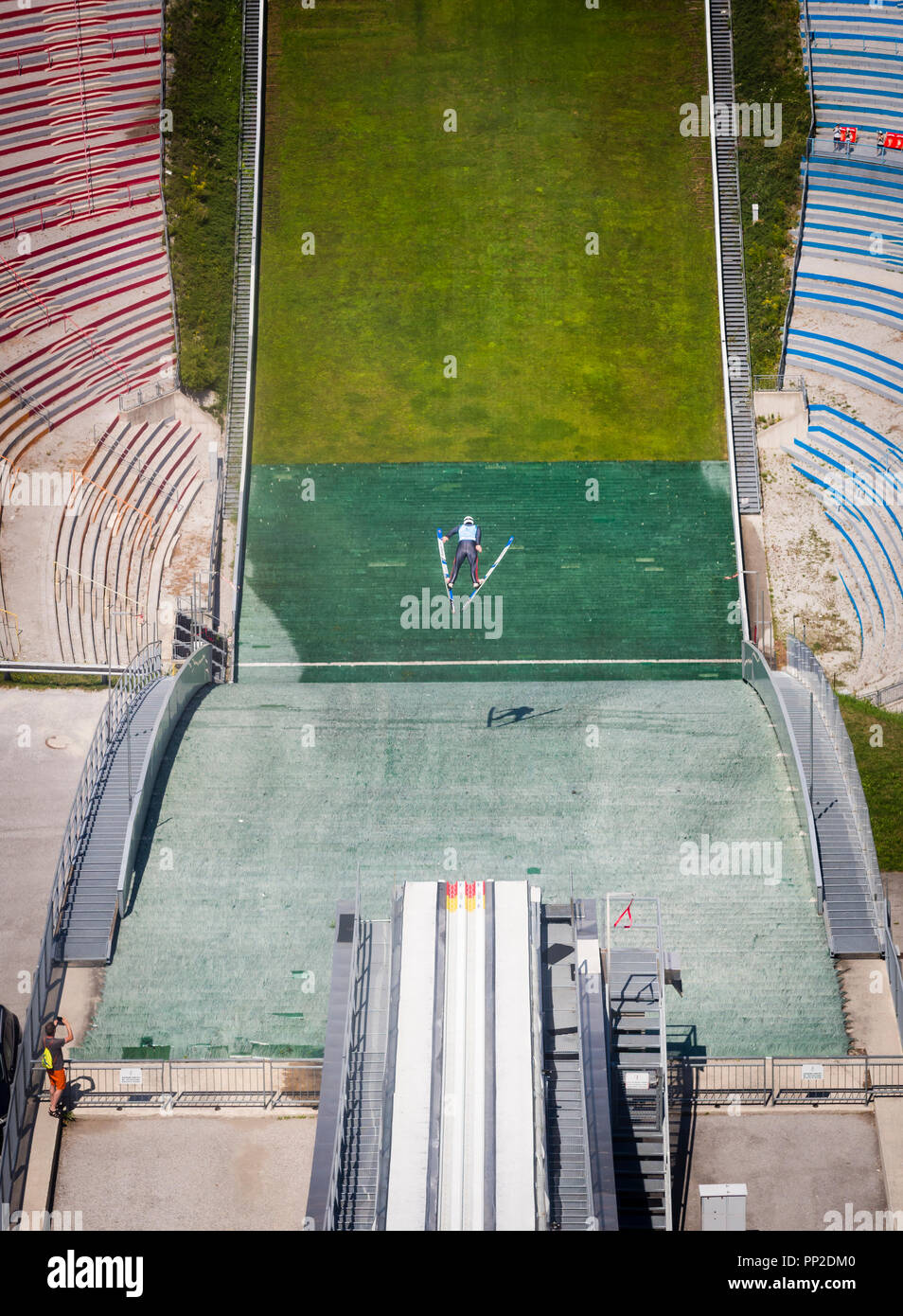 A ski jumper is flying up in the air during a summer training jump at ...