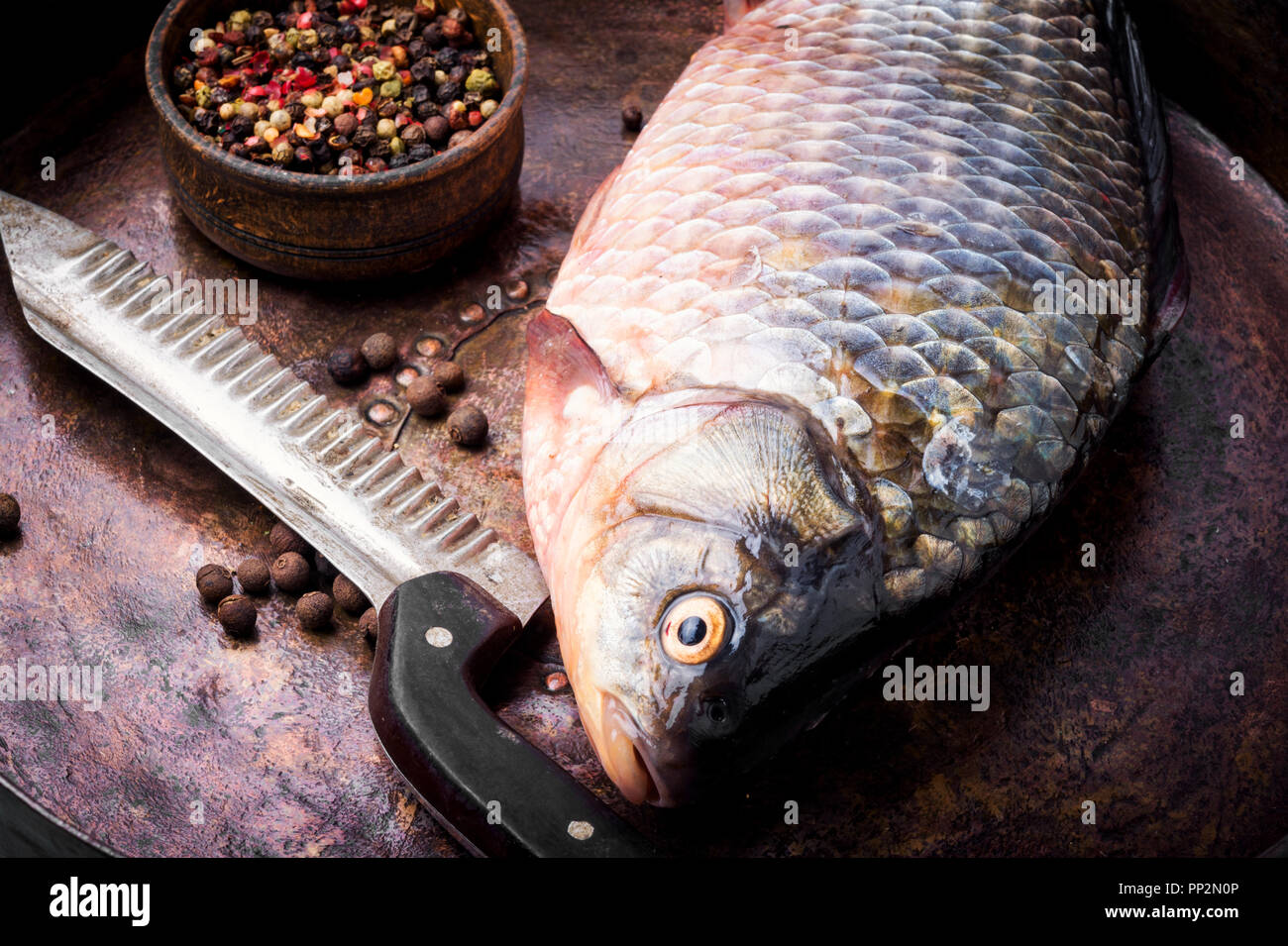 Fresh fish carp with ingredients for cooking on pan. Seafood Stock ...