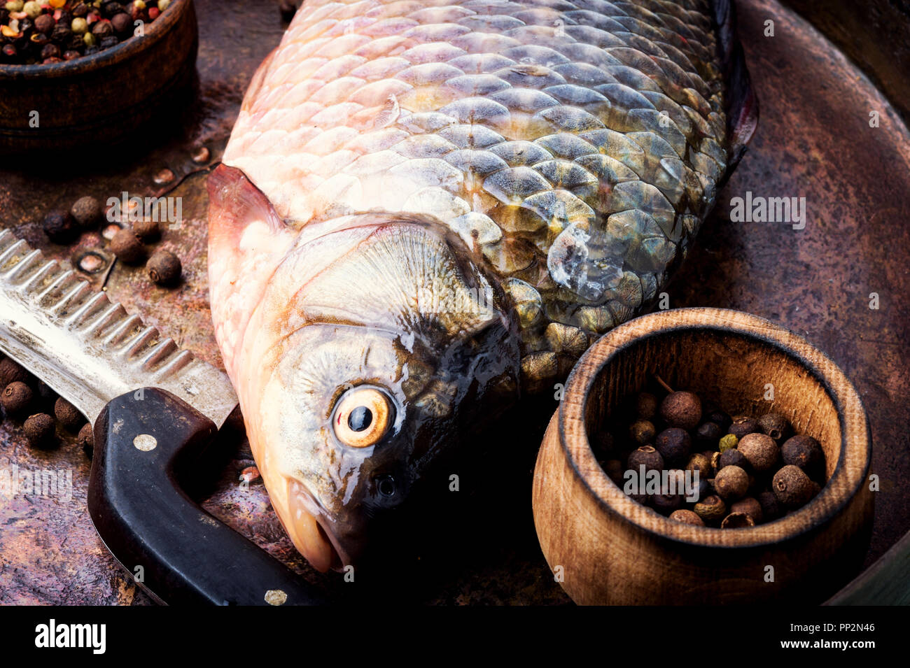 Fresh fish carp with ingredients for cooking on pan.Dietary food Stock ...