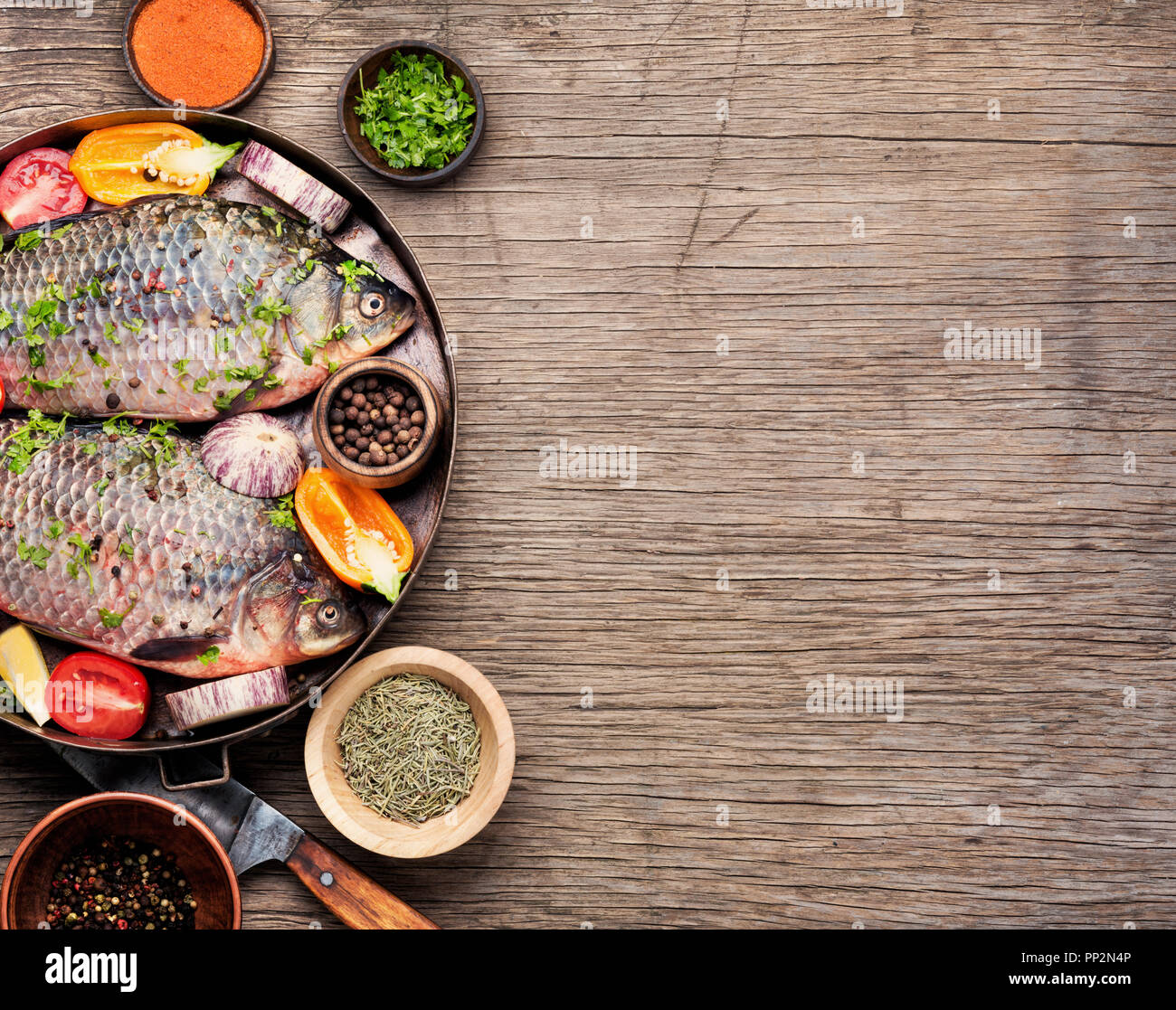 Fresh fish with ingredients for cooking on pan. Seafood Stock Photo - Alamy