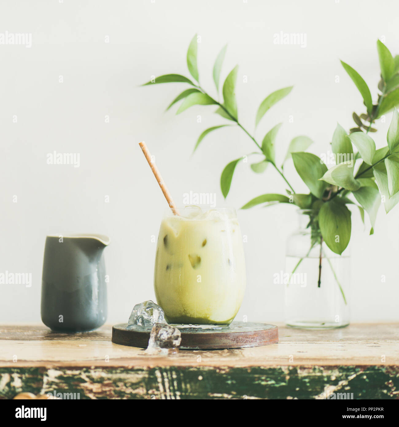 Iced matcha latte with milk pouring from pitcher, square crop Stock ...