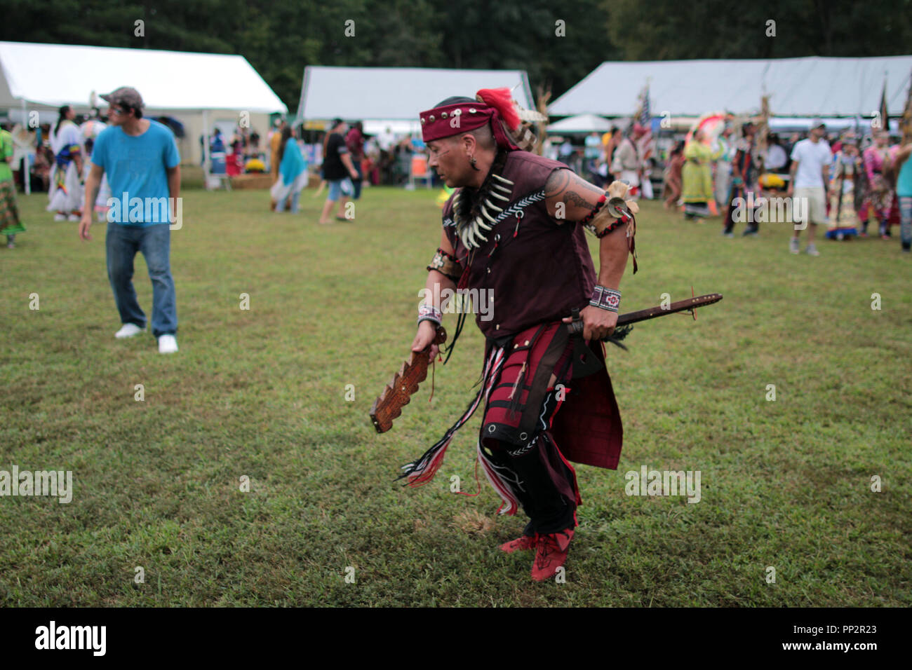 Native American performers dressed in traditional costumes dancing at ...