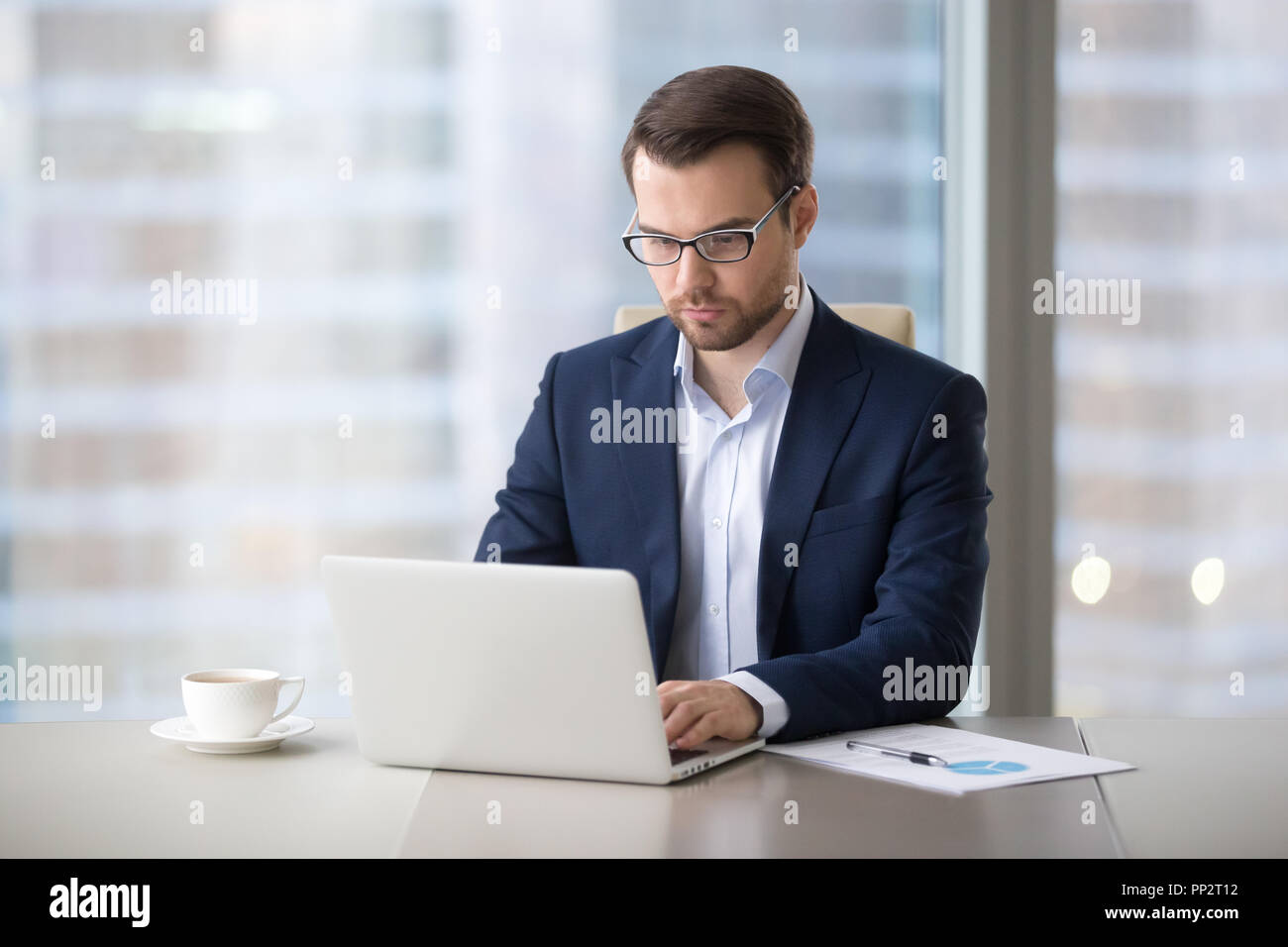 Serious businessman working typing letter on laptop Stock Photo - Alamy Serious businessman working typing letter on laptop Stock Photo - Alamy