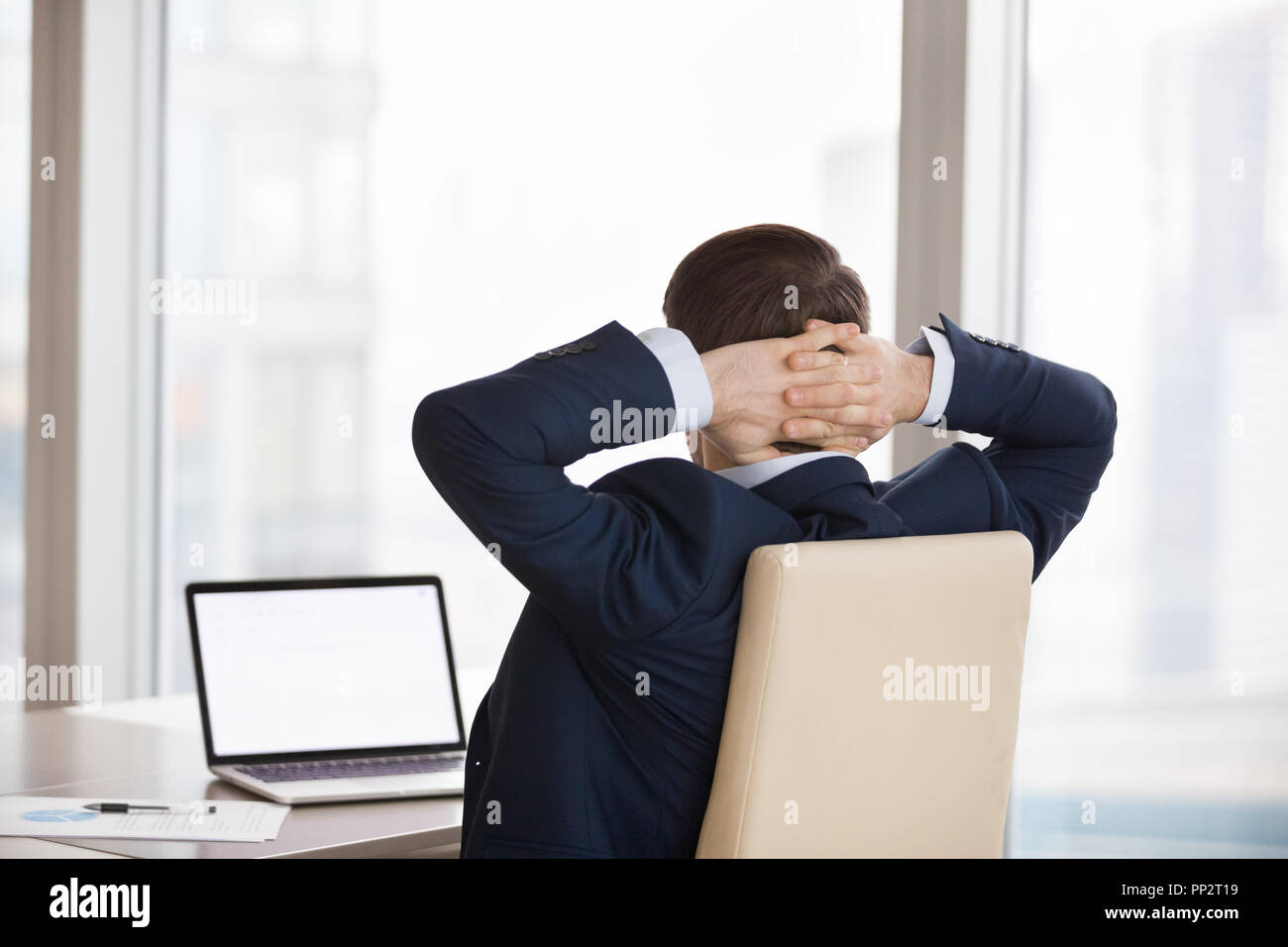 Man leaning back in chair hi-res stock photography and images - Alamy