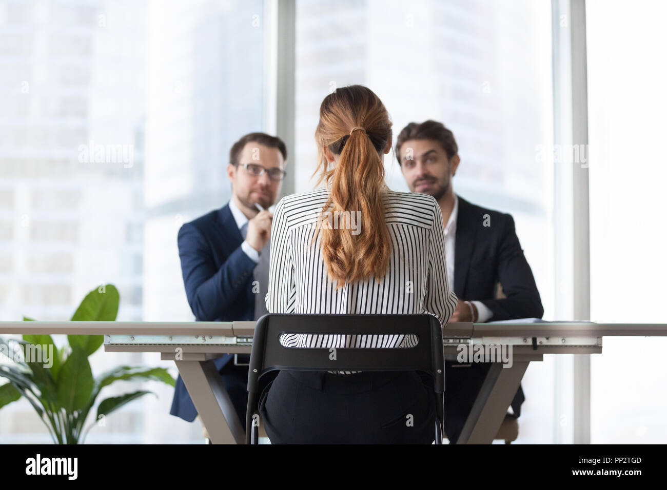 Female job candidate interview with doubting employers Stock Photo - Alamy