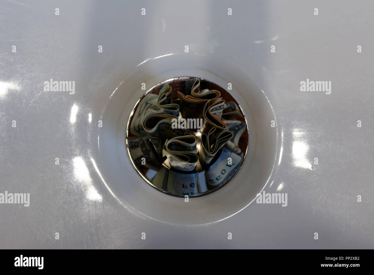 Throwing money down the drain hi-res stock photography and images - Alamy