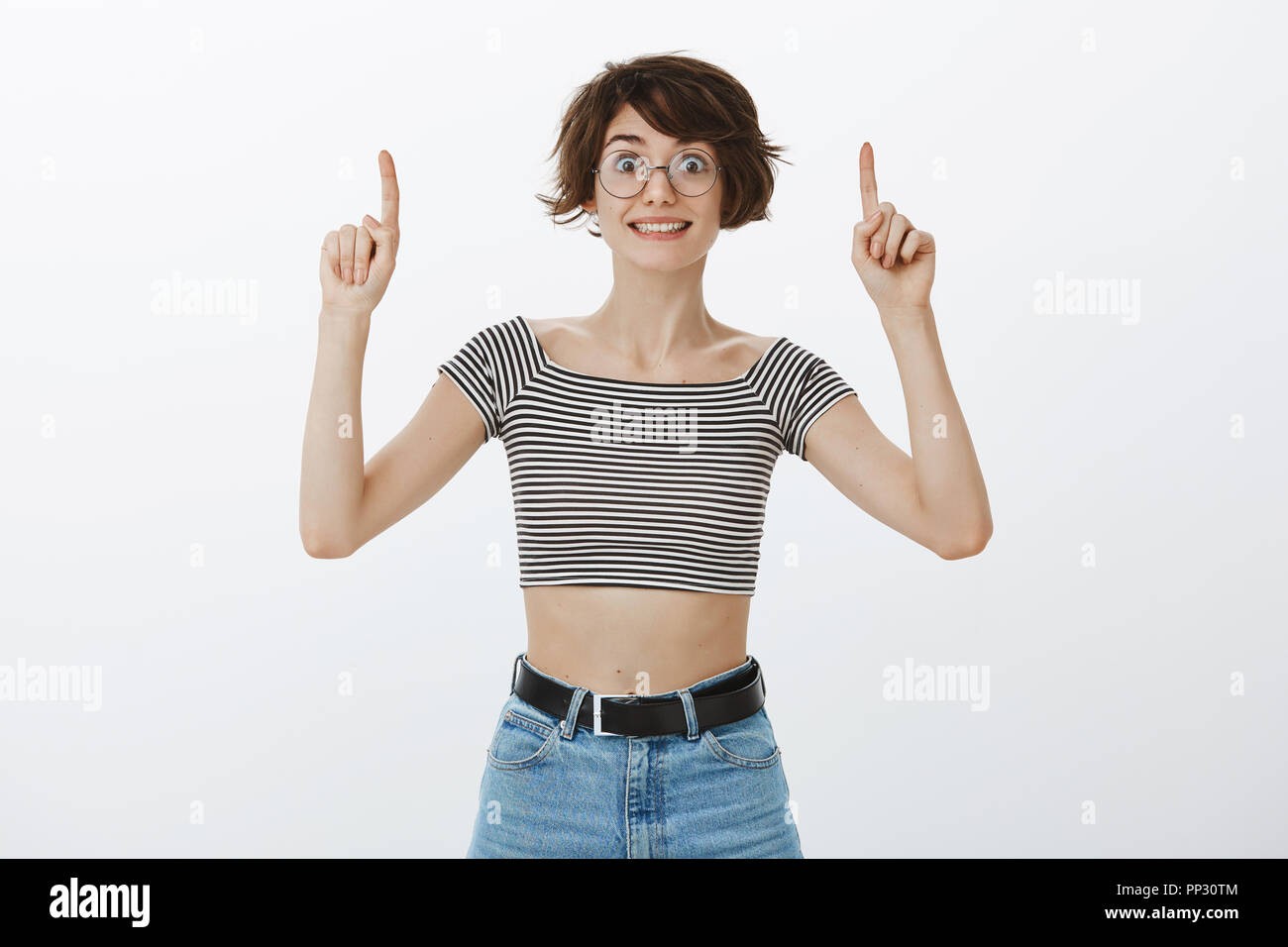 Portrait of excited overwhelmed attractive female studen in round ...