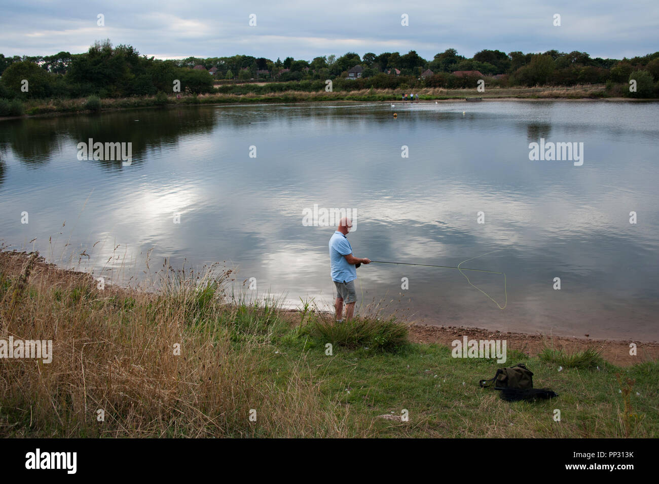 Fishermen fishing at the lakeside at Thryburgh Country Park in ...