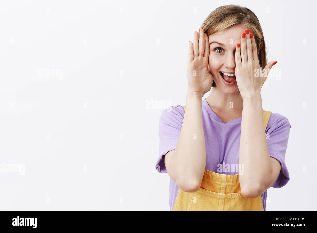 Horizontal shot of beautiful charming and playful female with fair ...