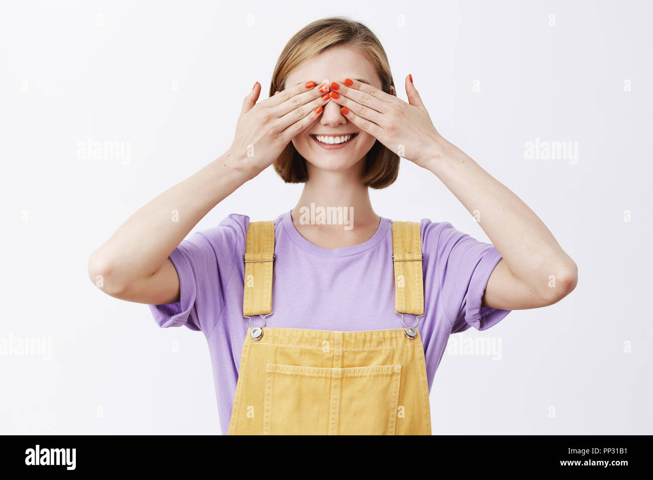 Promise I would not peek. Portrait of charming carefree european female ...