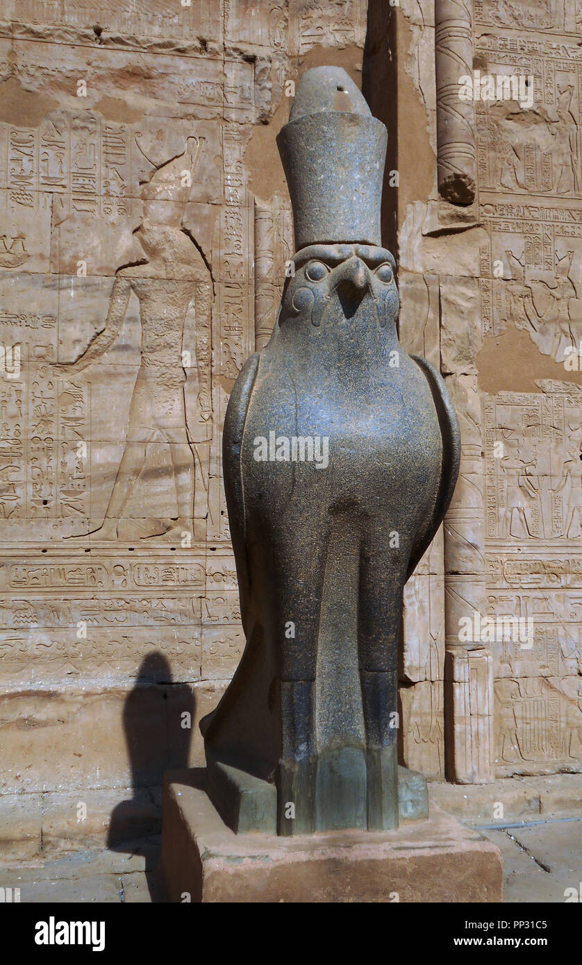 A huge, black granite, statue of Horus stands at the entrance to the ...