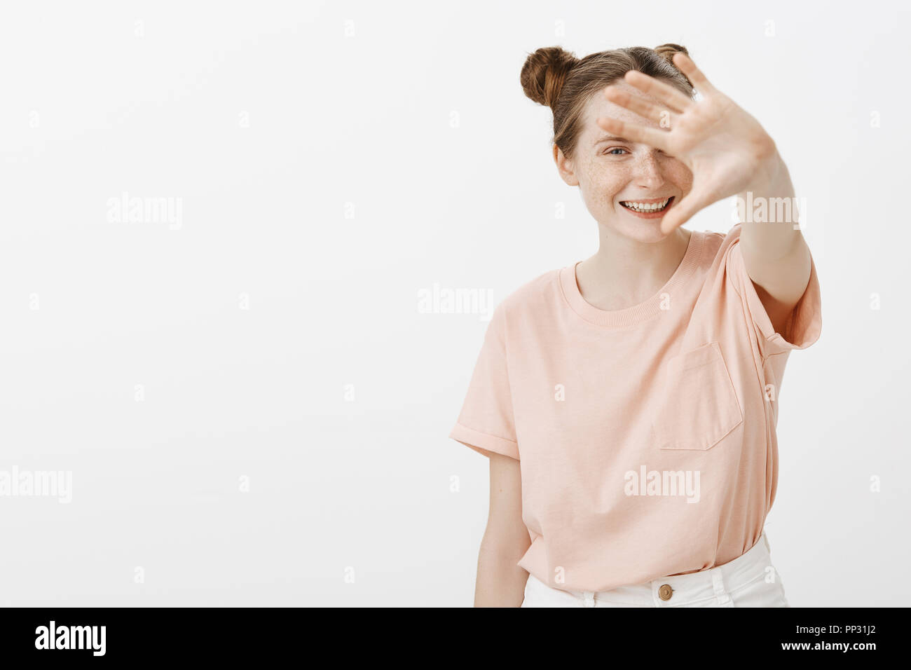 Girl blushing in front of camera, asking friend not taking pictures and ...