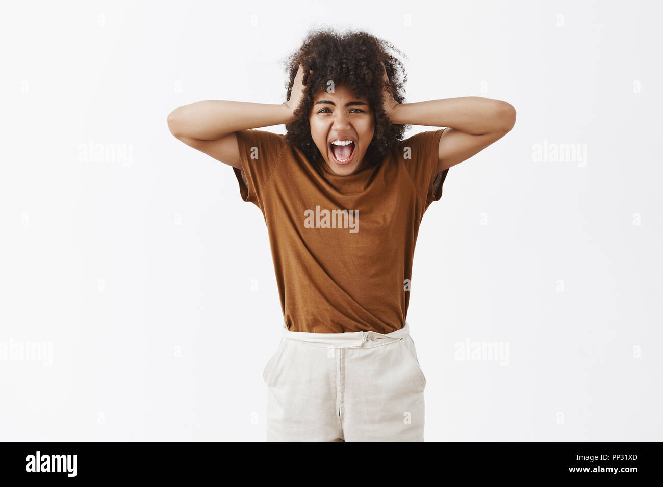 Distressed pissed fed up upset teenage girl with afro haircut yelling ...