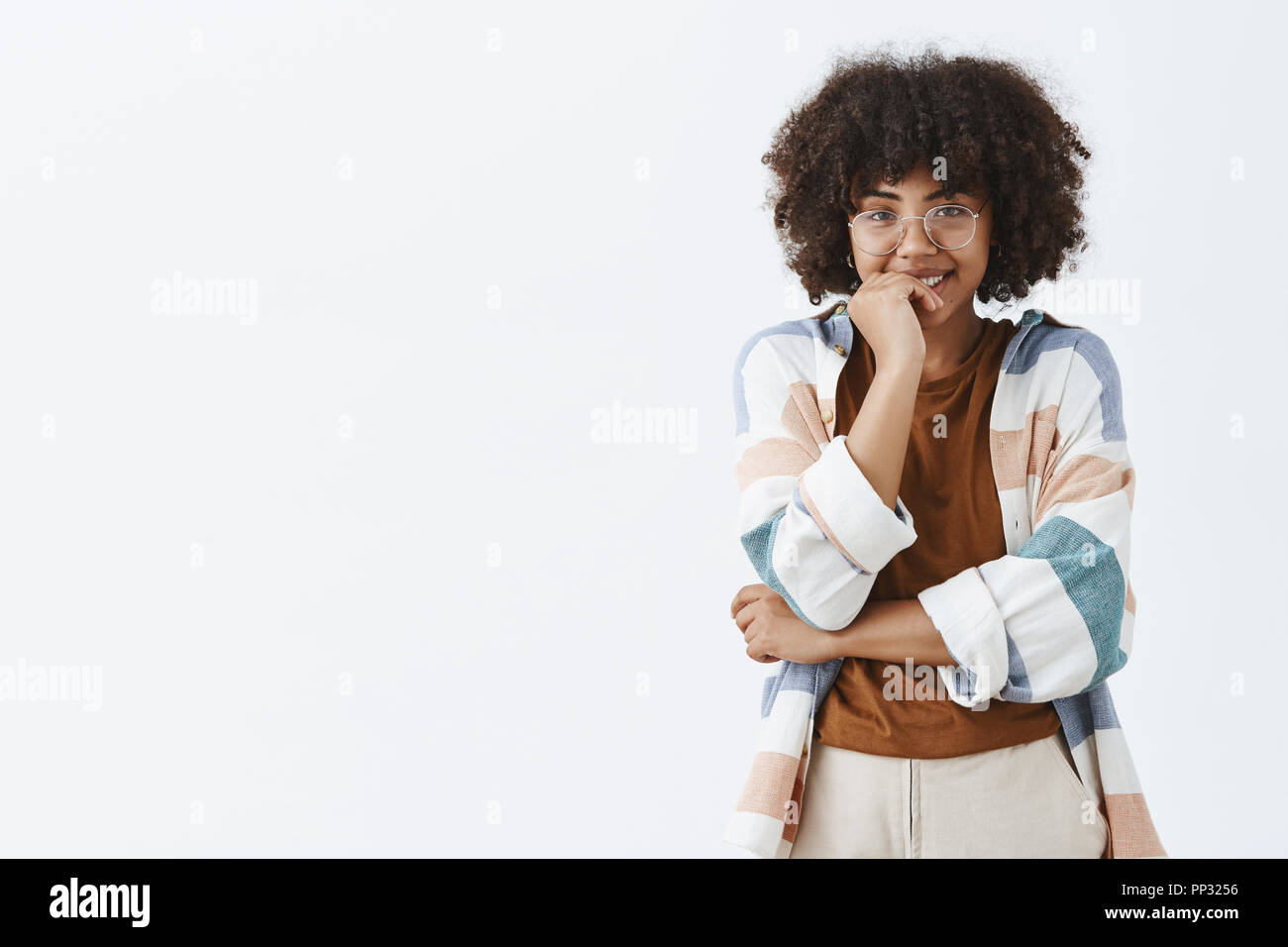 Indoor shot of silly and flirty cute dark-skinned female model with ...