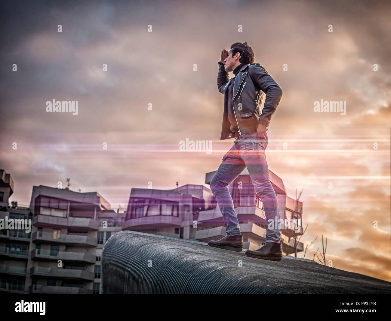 One handsome young man in urban setting in modern city, looking far ...