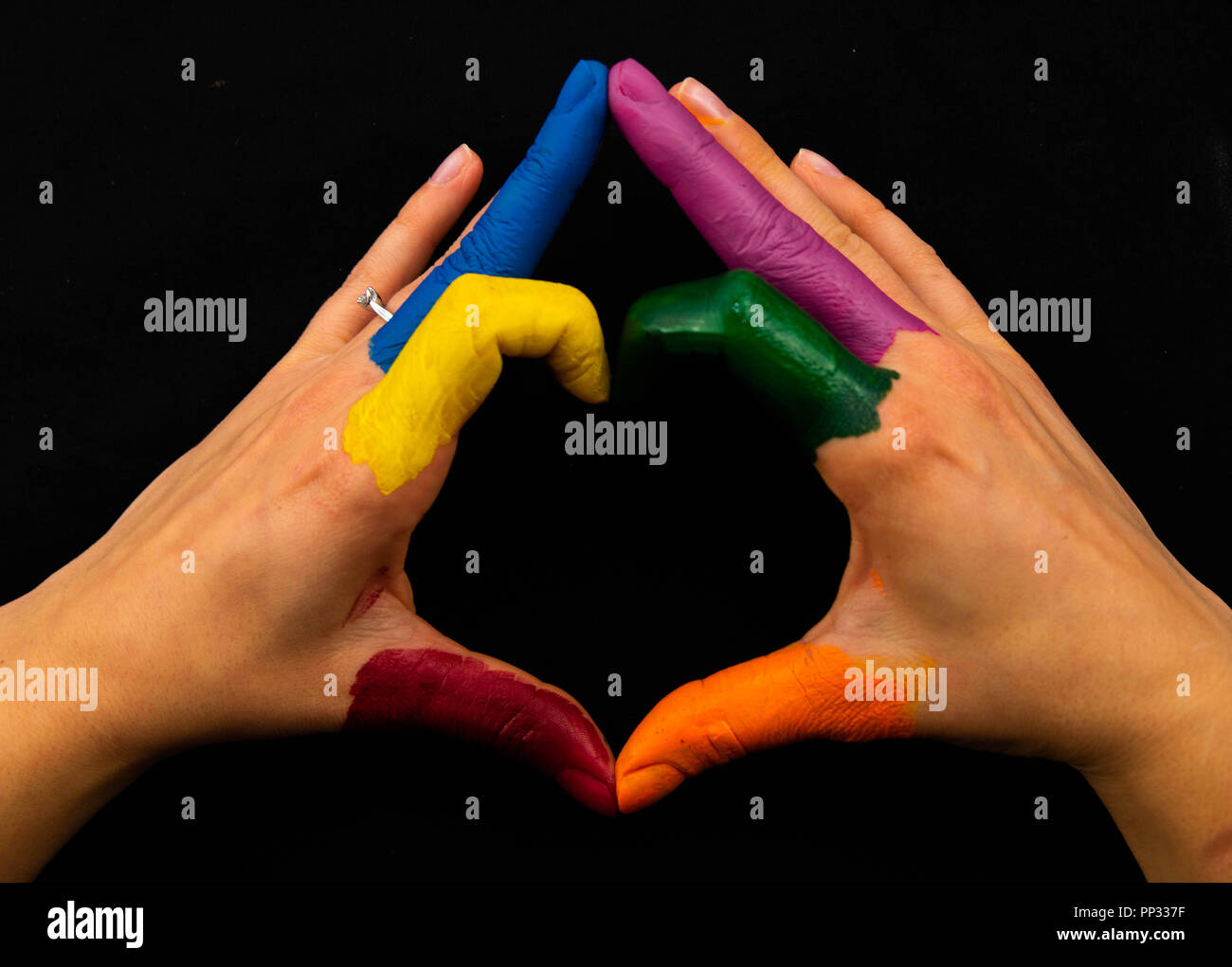Heart between hands hi-res stock photography and images - Alamy