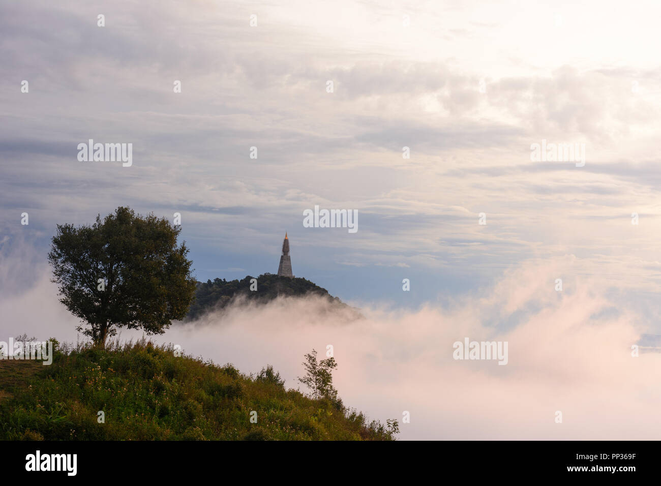 Vantage point atop a mountain covered with fog all over the area. Along ...