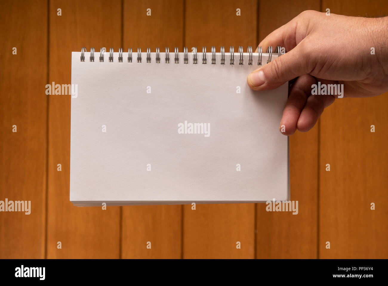a block of note paper in hand Stock Photo - Alamy