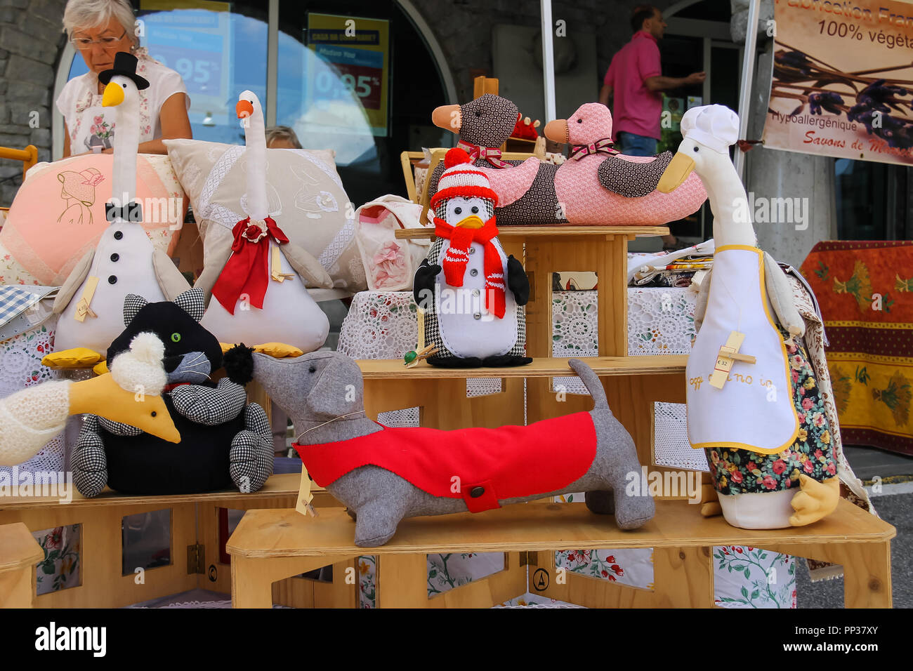 Fanano, Italy - July 3, 2016: Elderly woman in glasses near souvenir ...