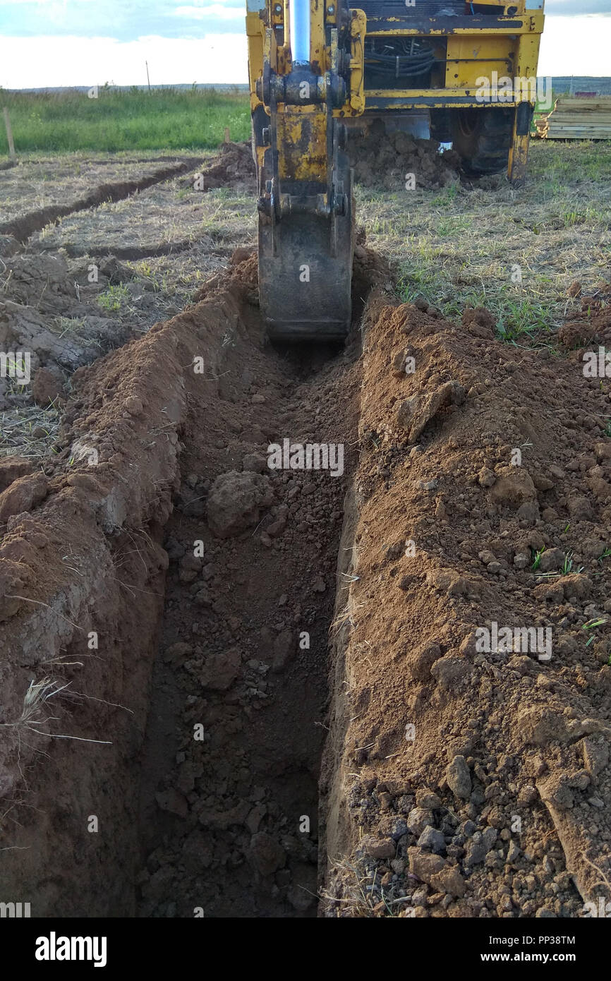 View from above at Working Excavator Tractor Digging A Trench Stock ...