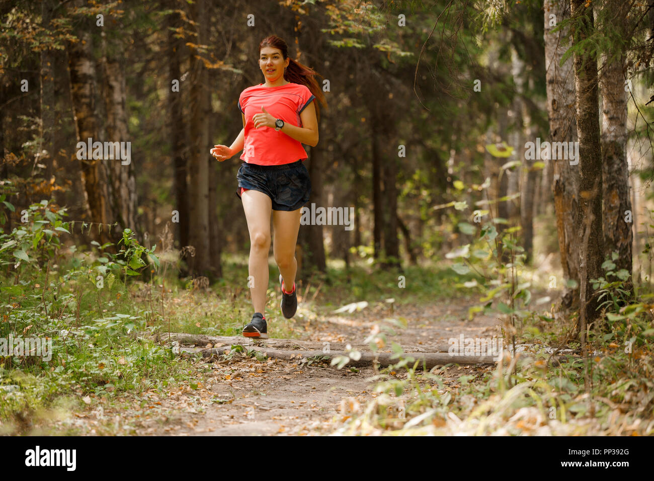 Photo of sports girl running through park on summer day Stock Photo - Alamy