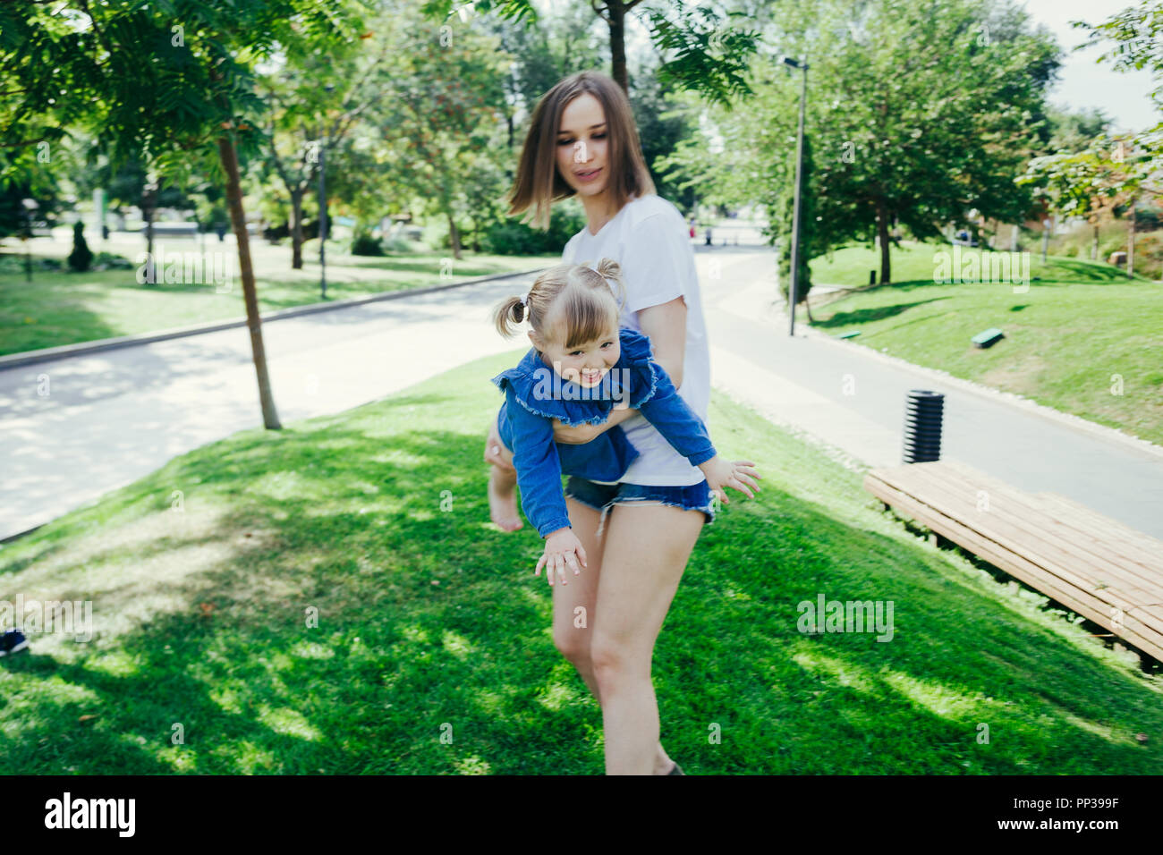 Portrait Of A Young Mother And Her 3 Years Old Daughter Playing In A