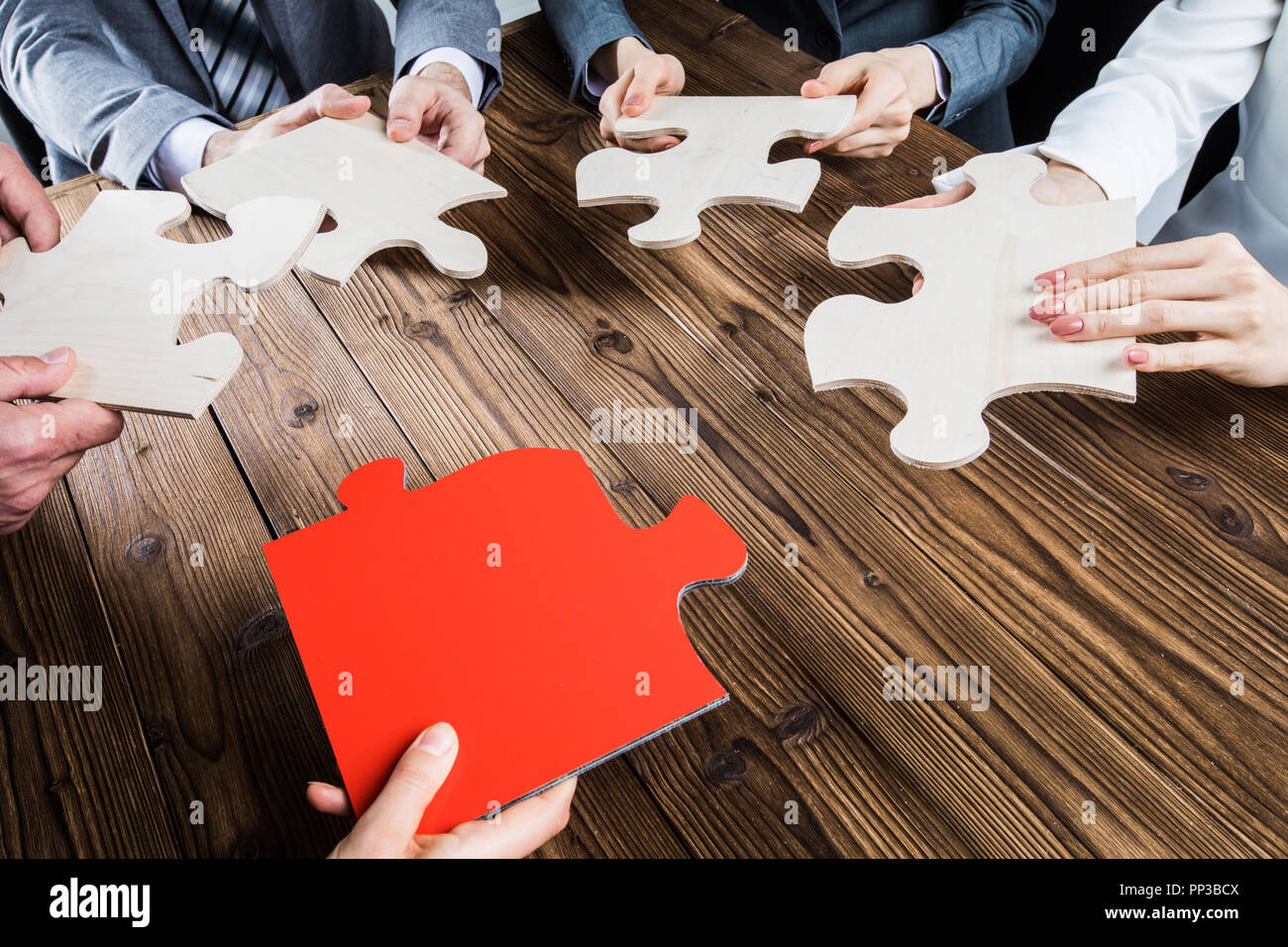 Group of business people assembling jigsaw puzzle and represent team ...